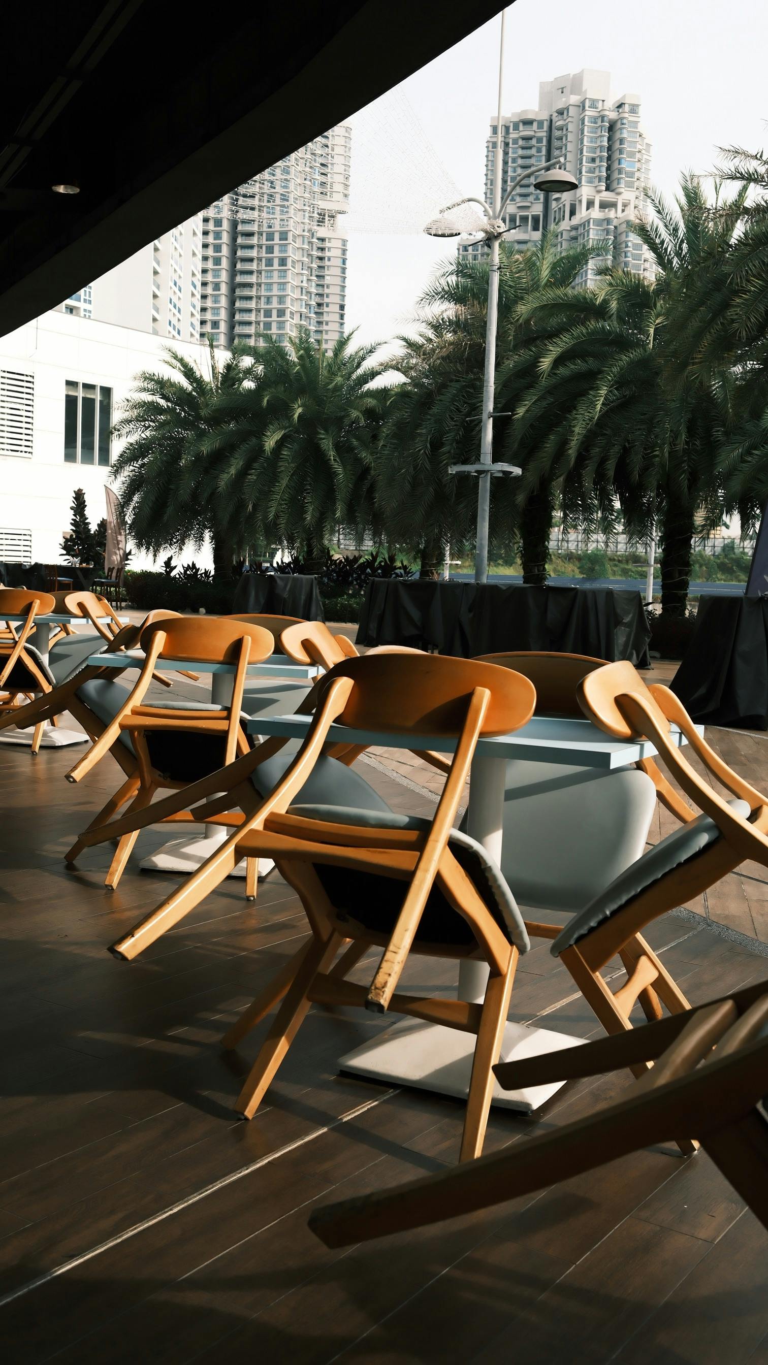 Outdoor Restaurant Chairs in Urban Setting · Free Stock Photo