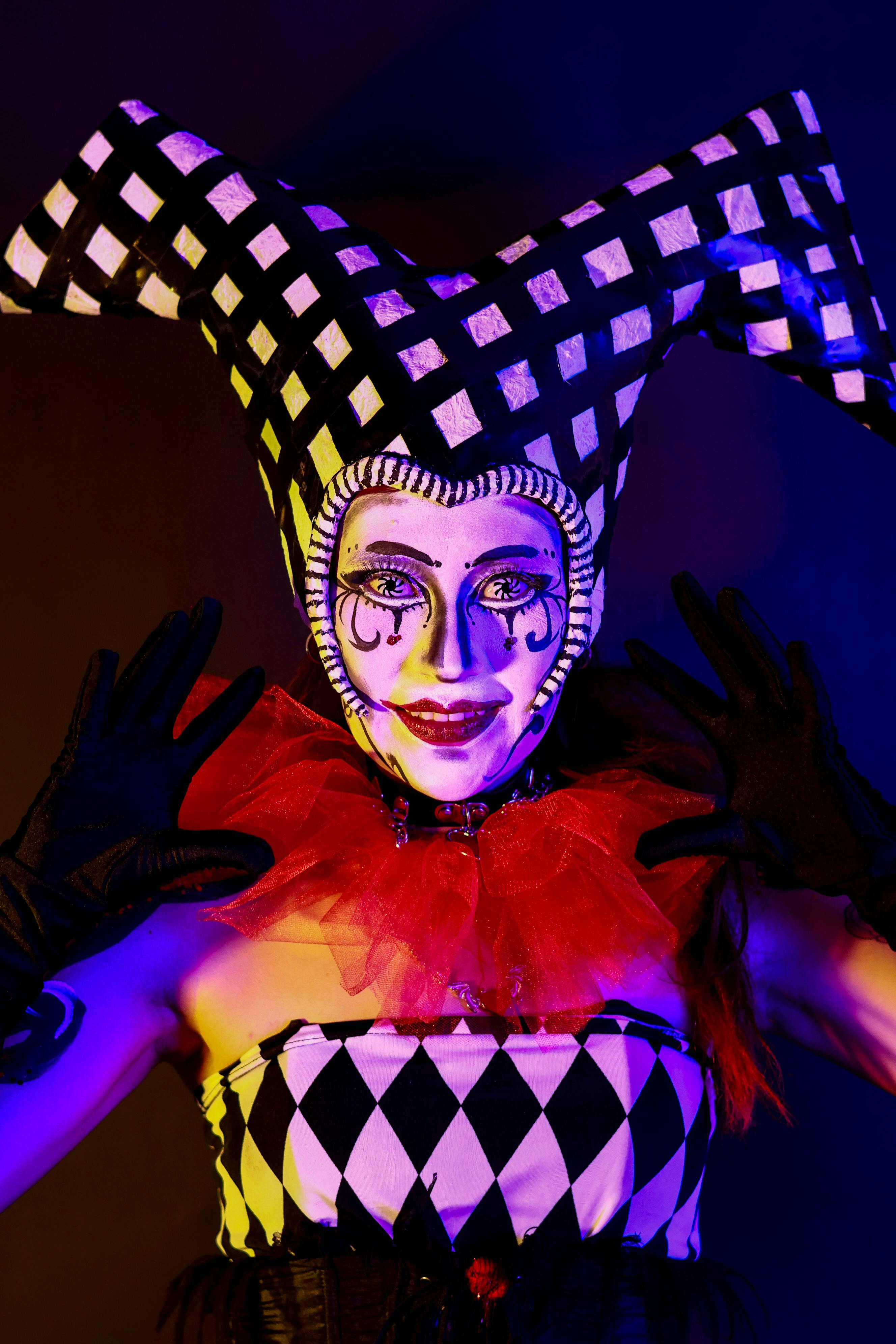 Colorful Jester in Vibrant Costume with Dramatic Lighting · Free Stock ...