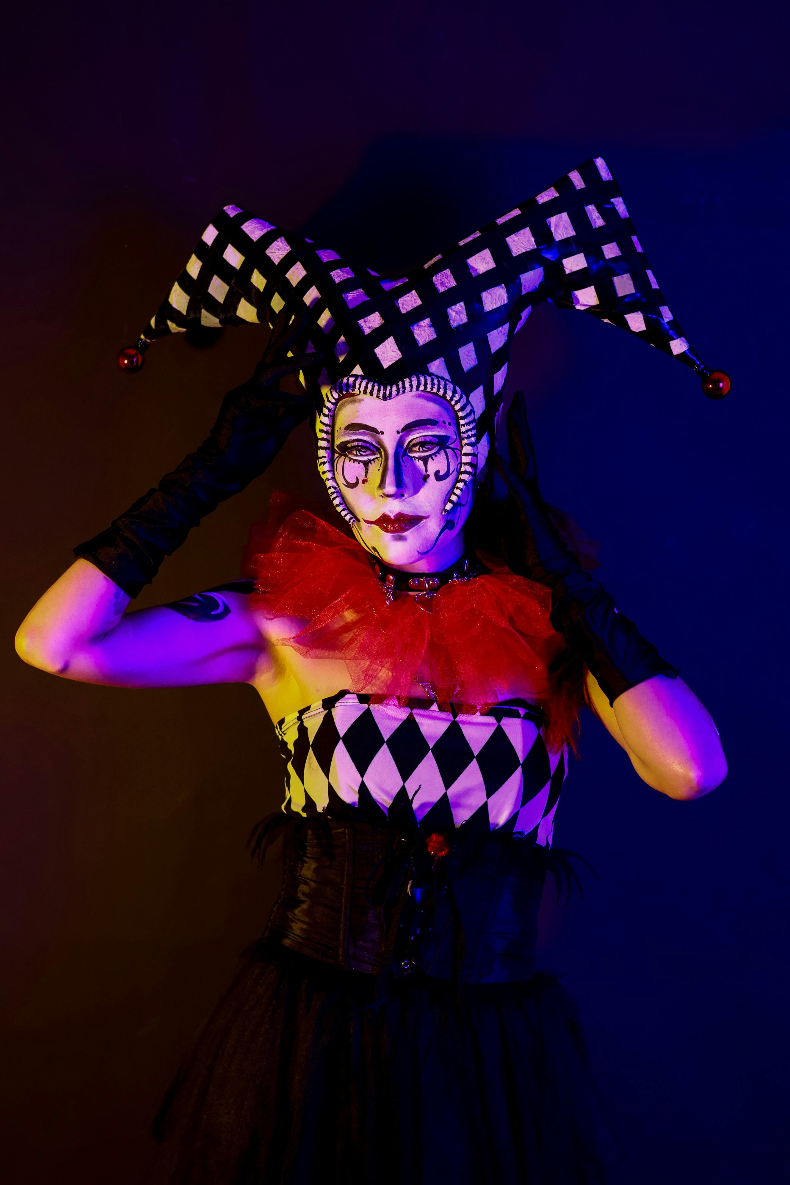 Mysterious Harlequin Jester in Colorful Costume · Free Stock Photo