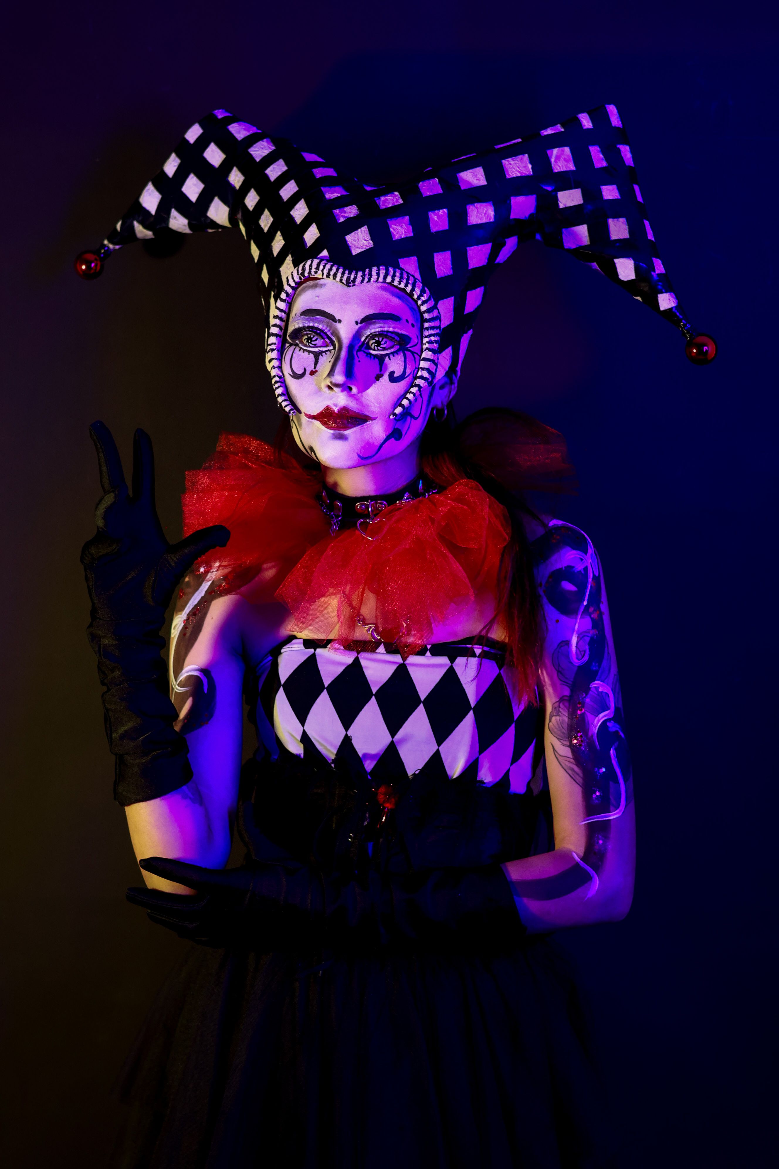 Colorful Jester in Dramatic Stage Lighting · Free Stock Photo