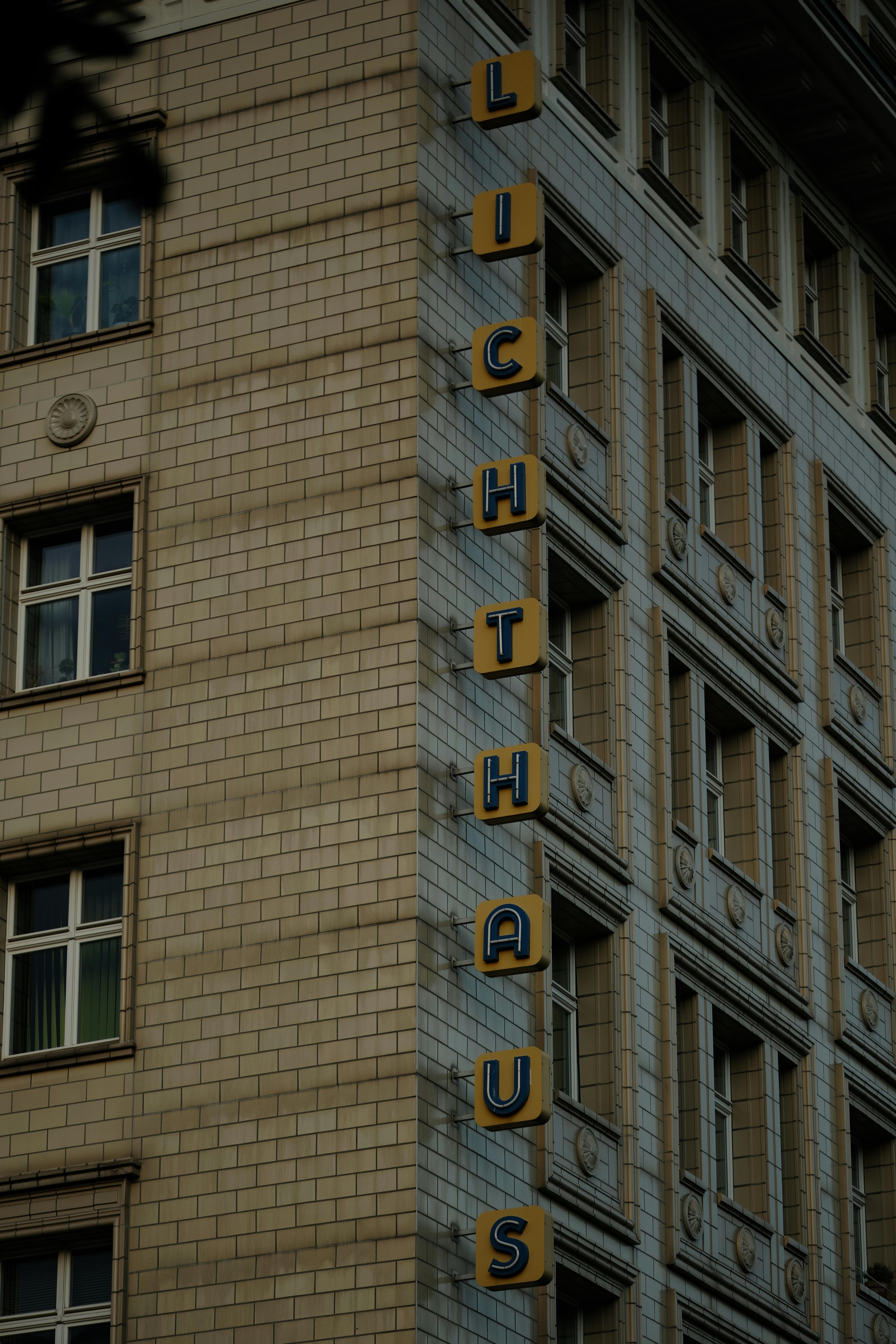 Vintage Brick Building with Signage at Night · Free Stock Photo