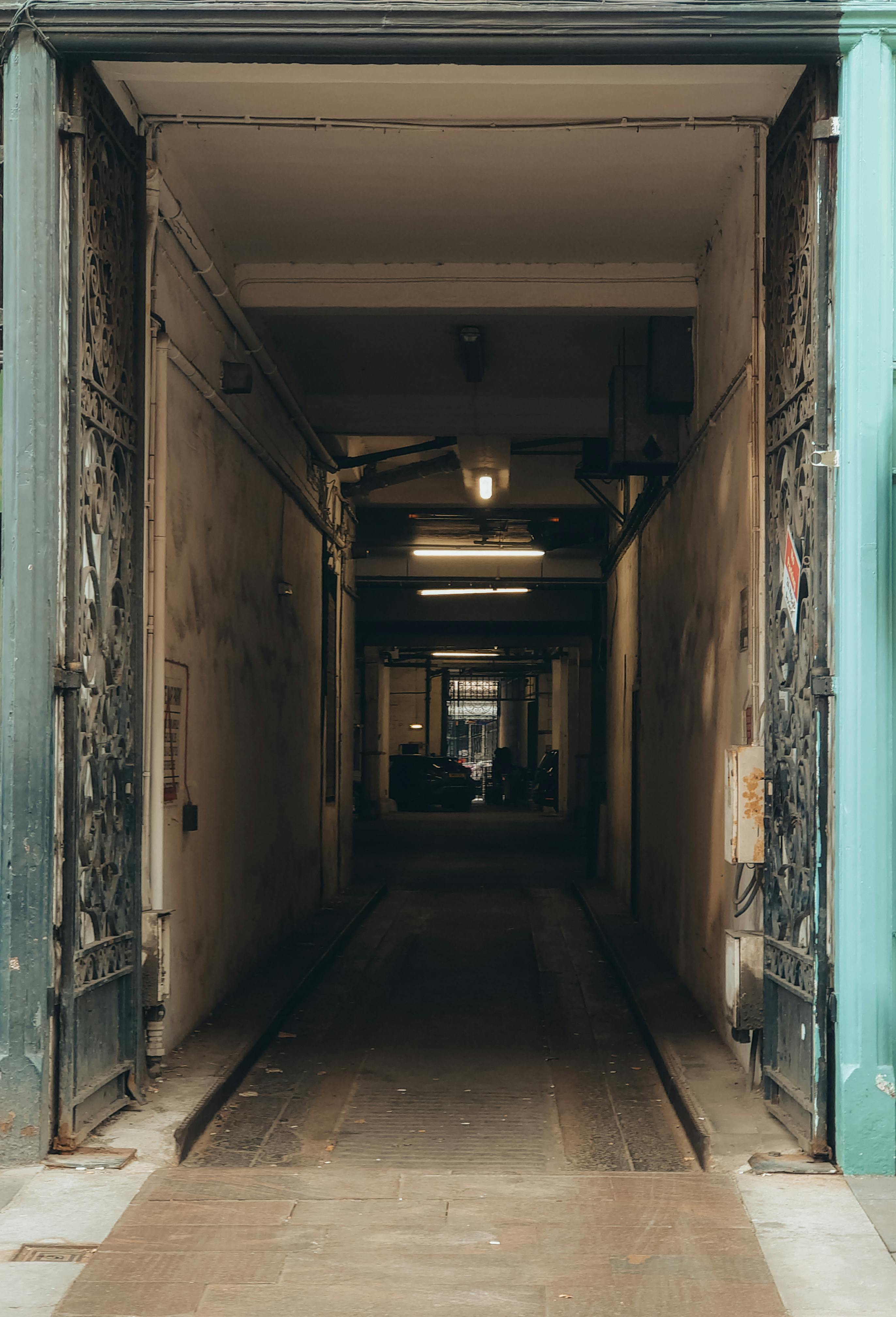 Gated Urban Alley Entrance with Historical Architecture · Free Stock Photo