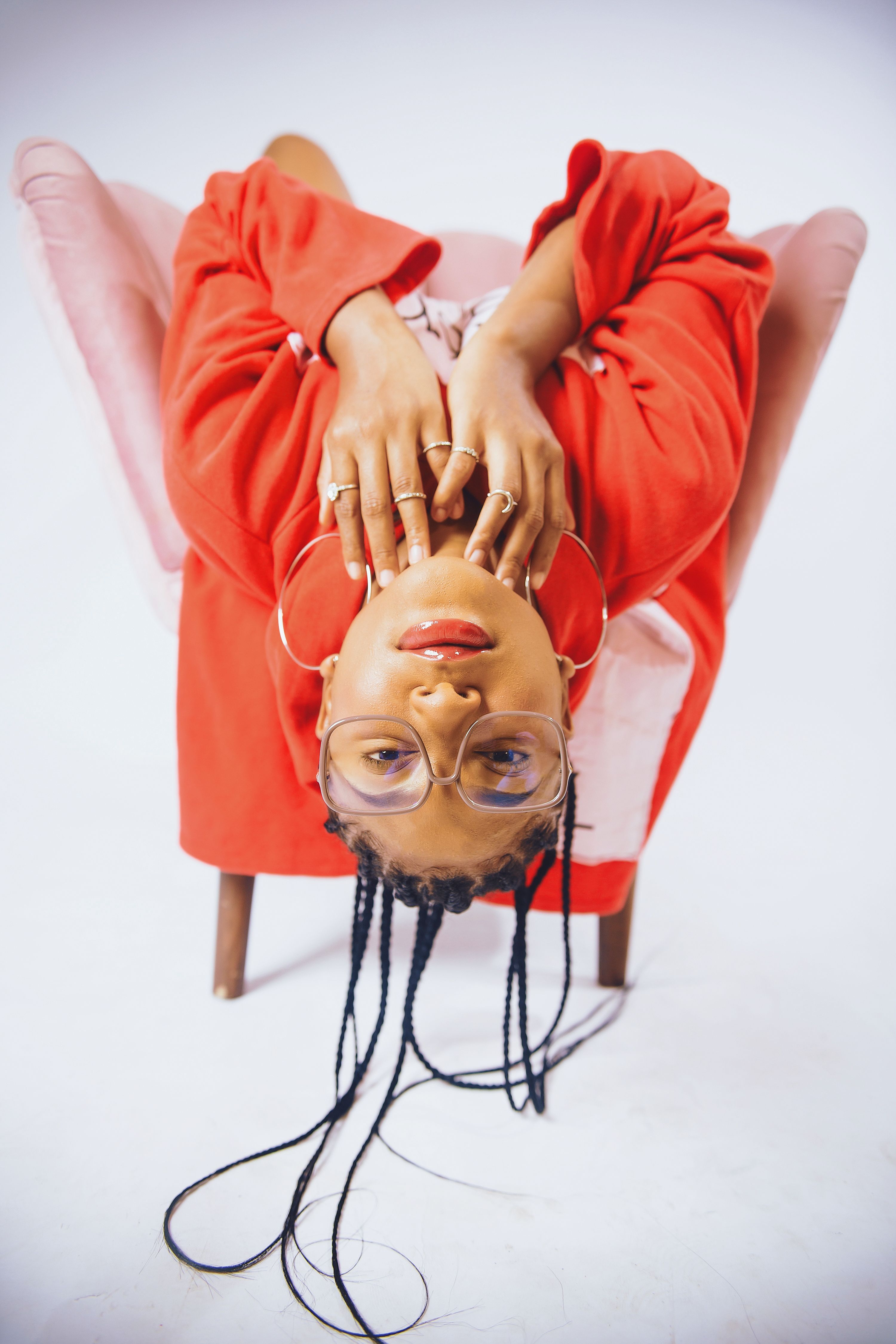 Young Woman in Red Clothing Posing Upside Down · Free Stock Photo