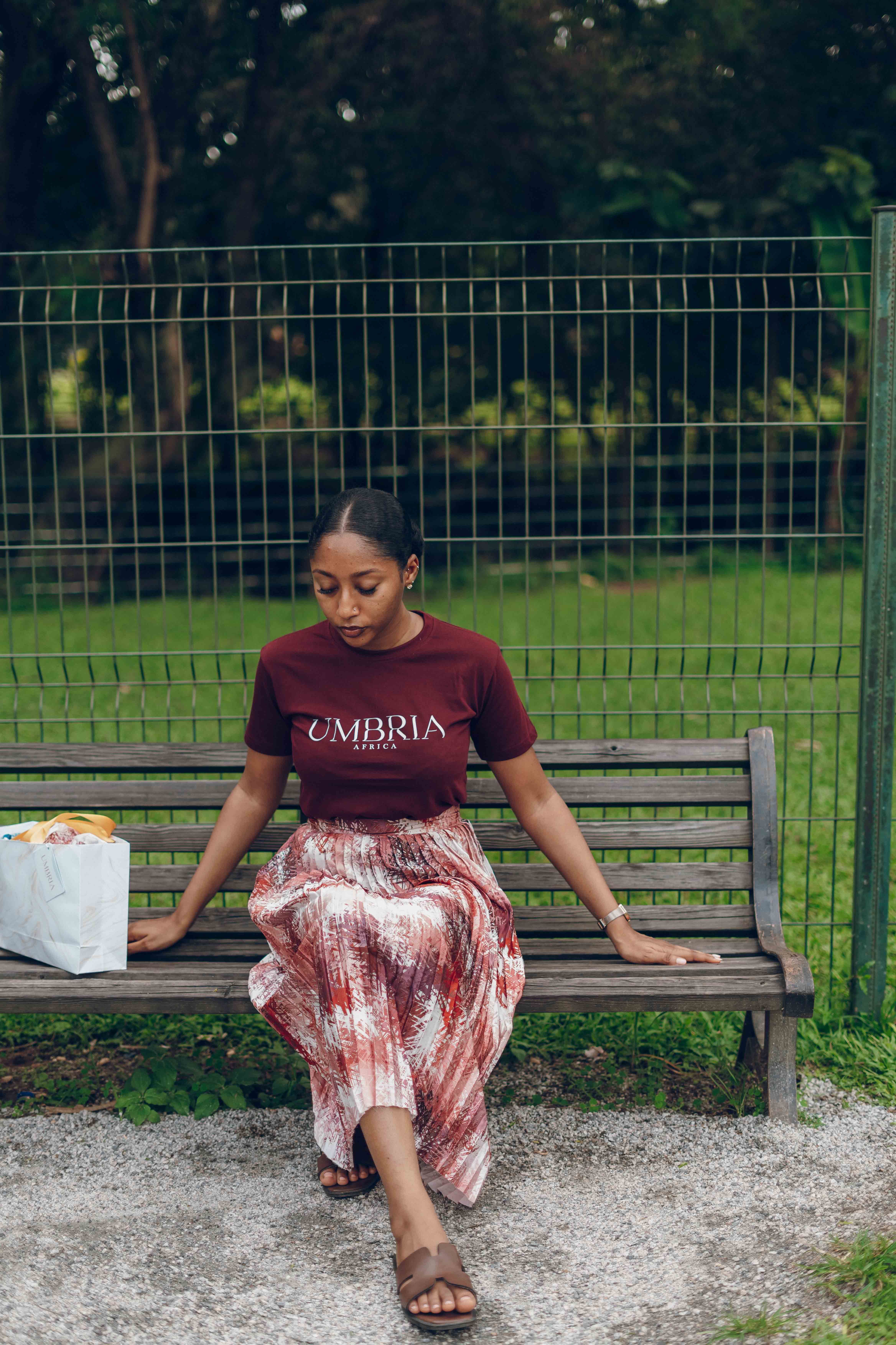 Young Woman Relaxing on Park Bench in Nigeria · Free Stock Photo