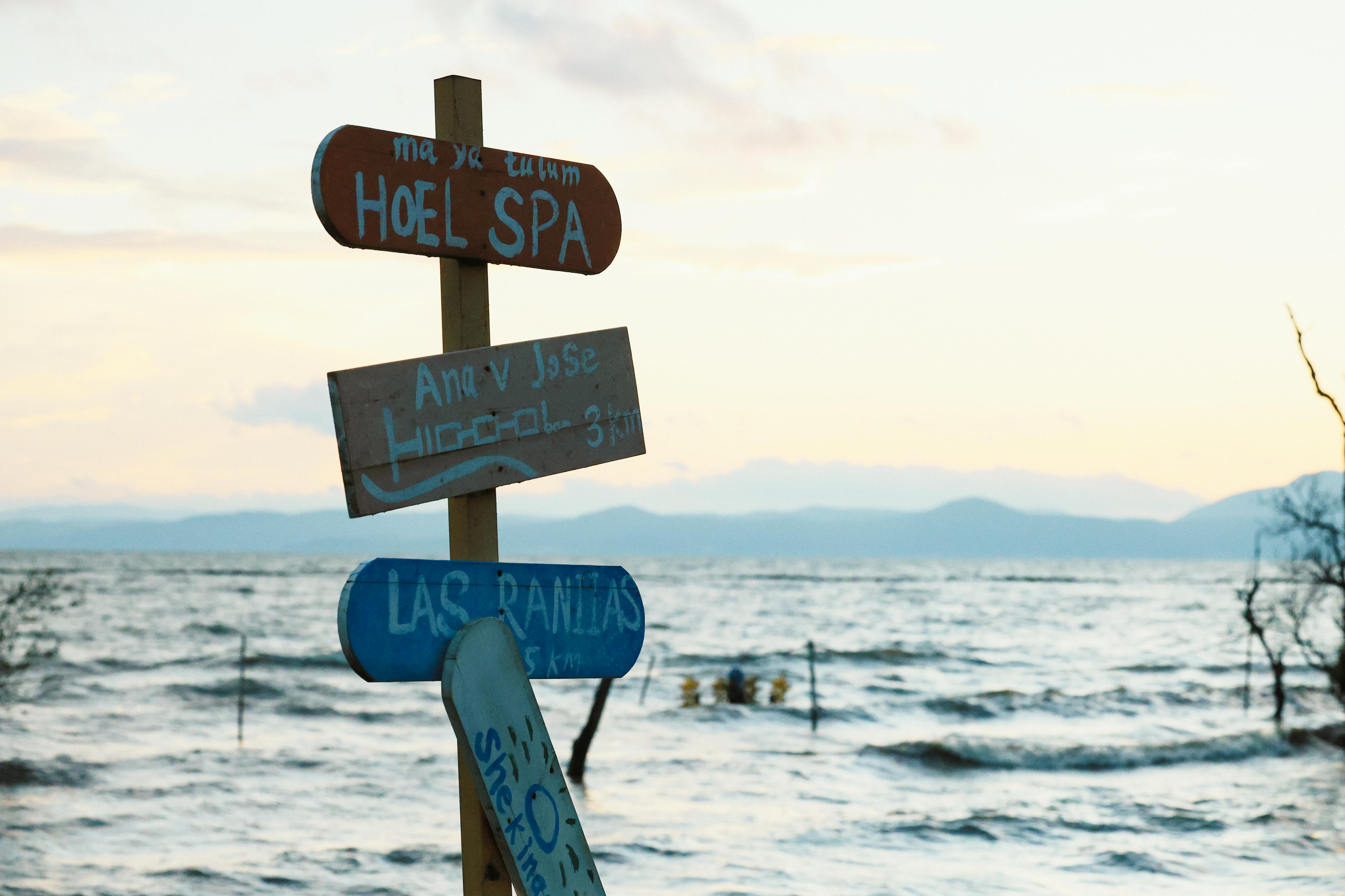 Beachside Signposts at Sunset by the Sea · Free Stock Photo