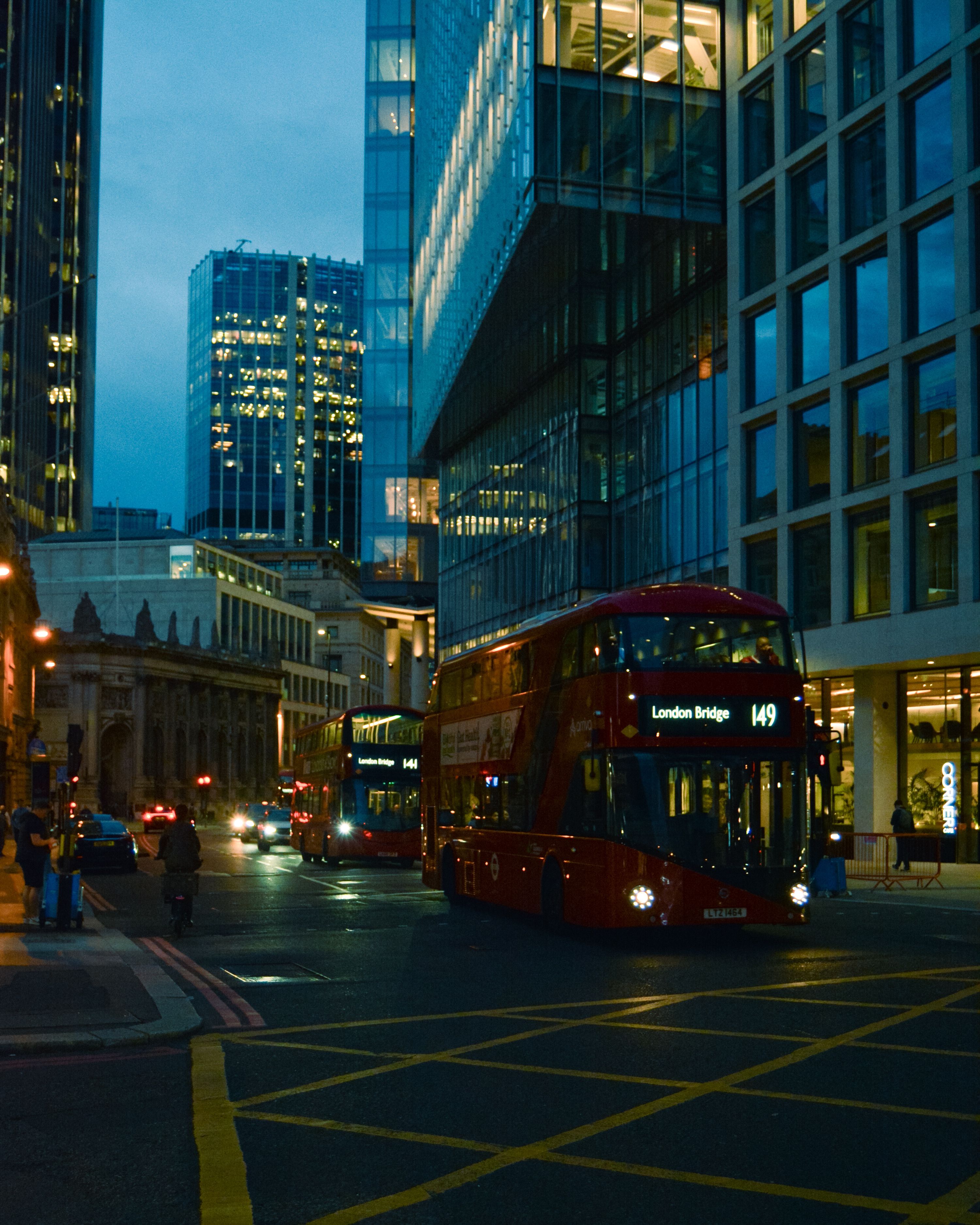 Double-deck Bus Parked Surrounded by Buildings · Free Stock Photo