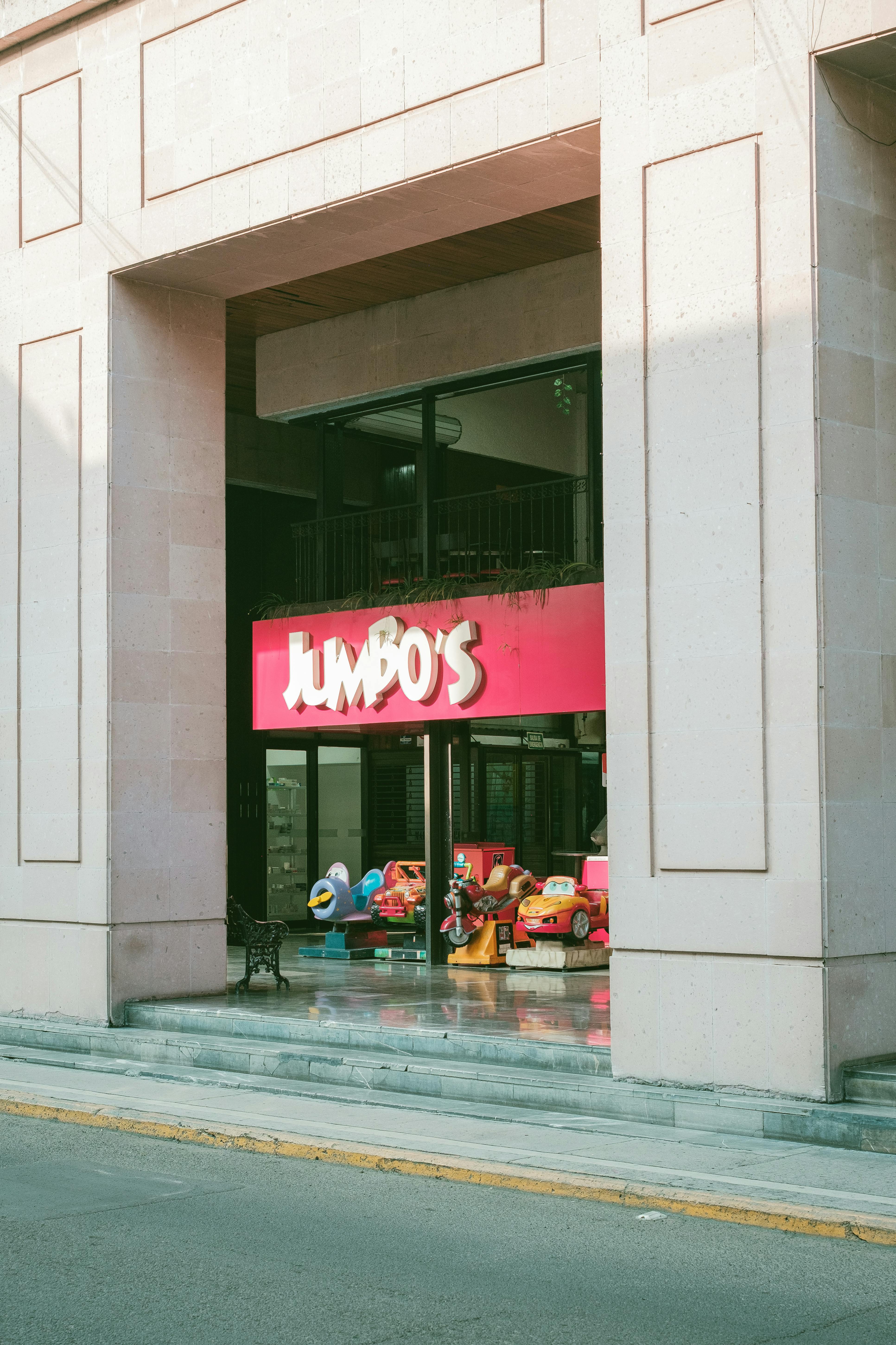 Entrance to Jumbo's Toy Store Featuring Rides · Free Stock Photo