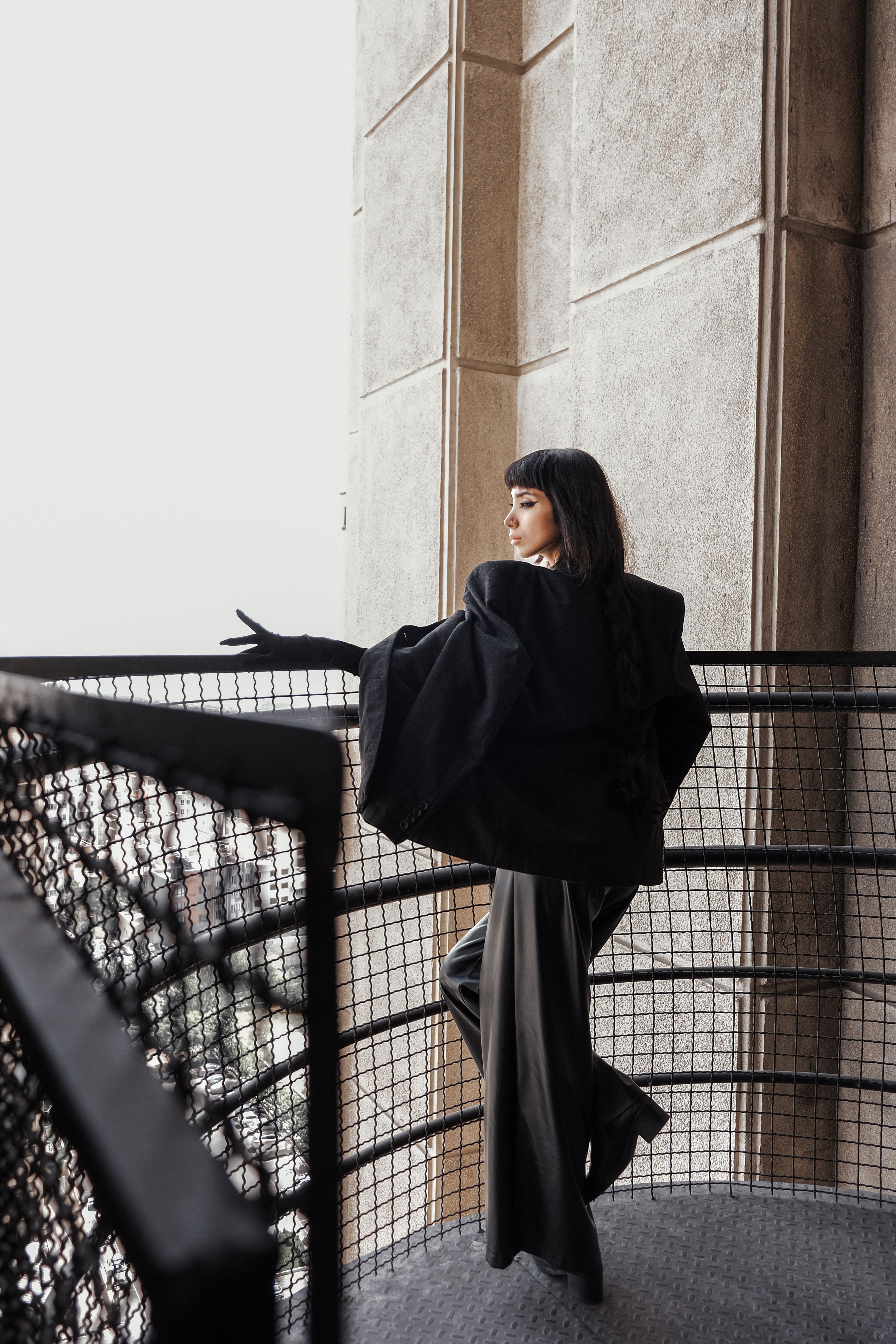 Chic Woman Standing on Urban Balcony · Free Stock Photo