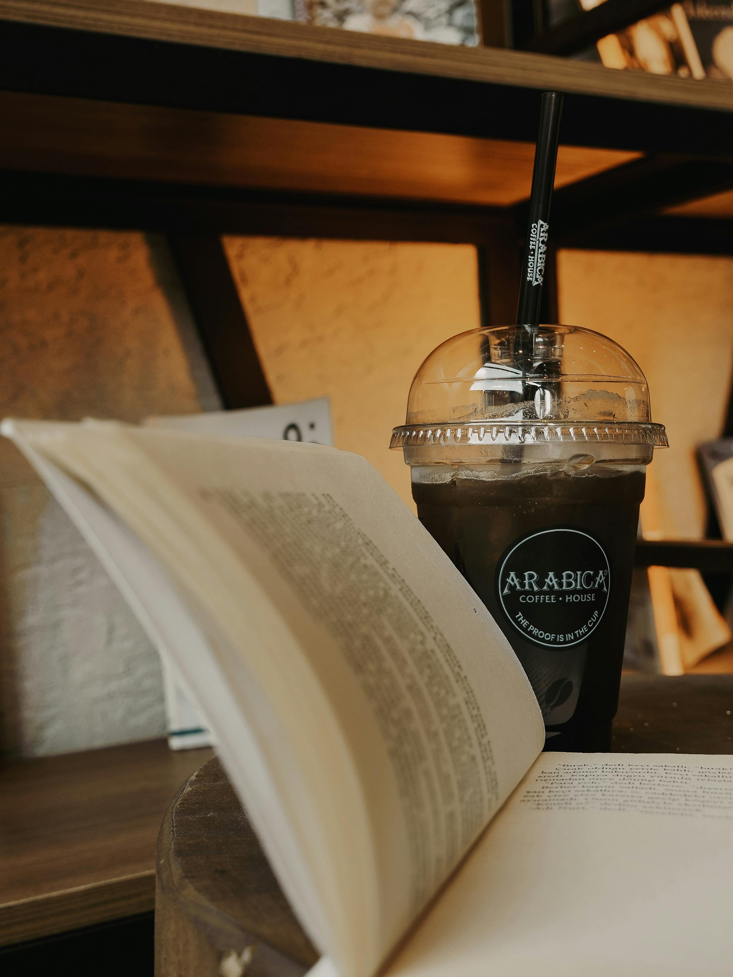 Relaxing Coffee and Reading Setup in Cozy Cafe · Free Stock Photo