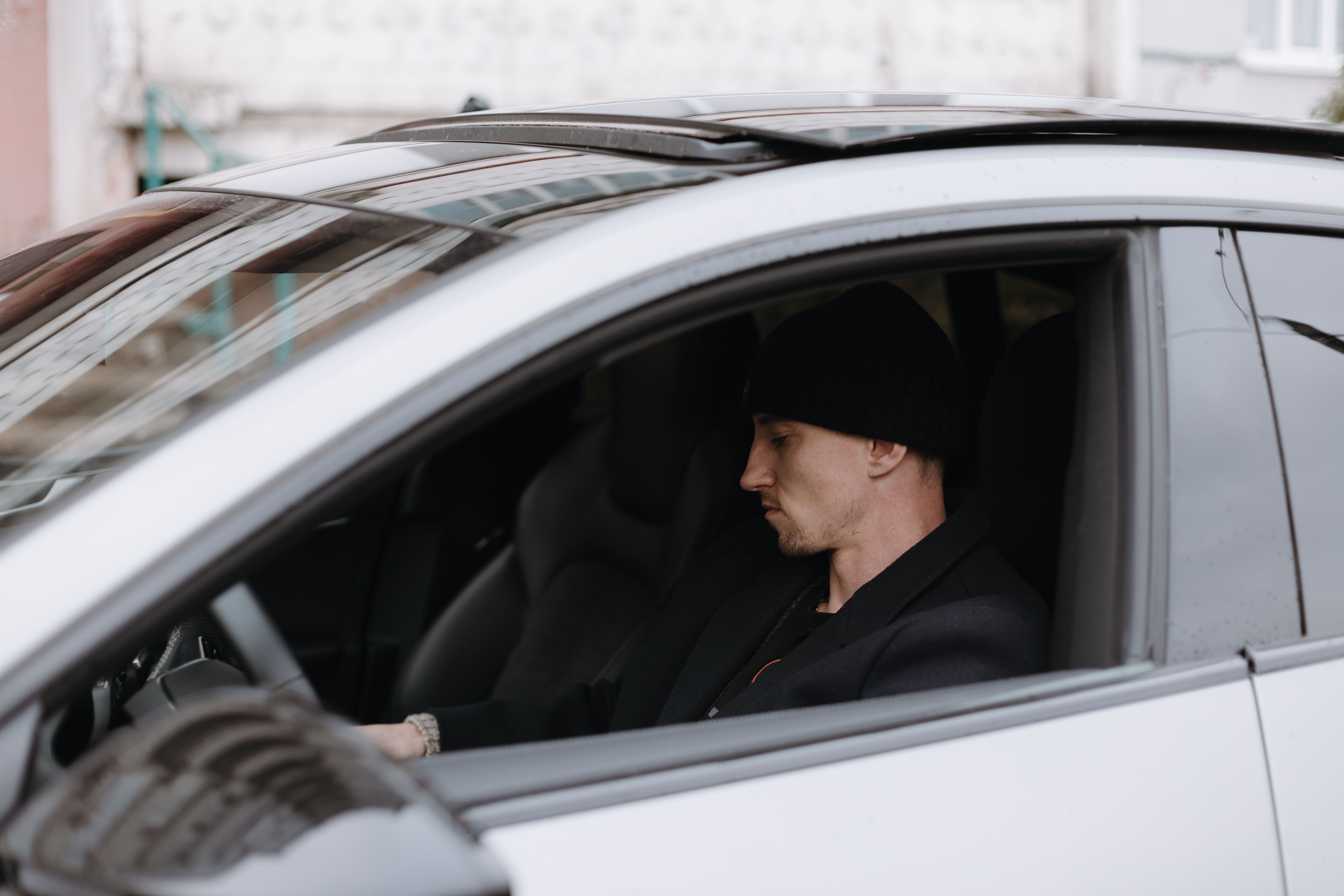 Man in Car Wearing Black Beanie and Jacket · Free Stock Photo