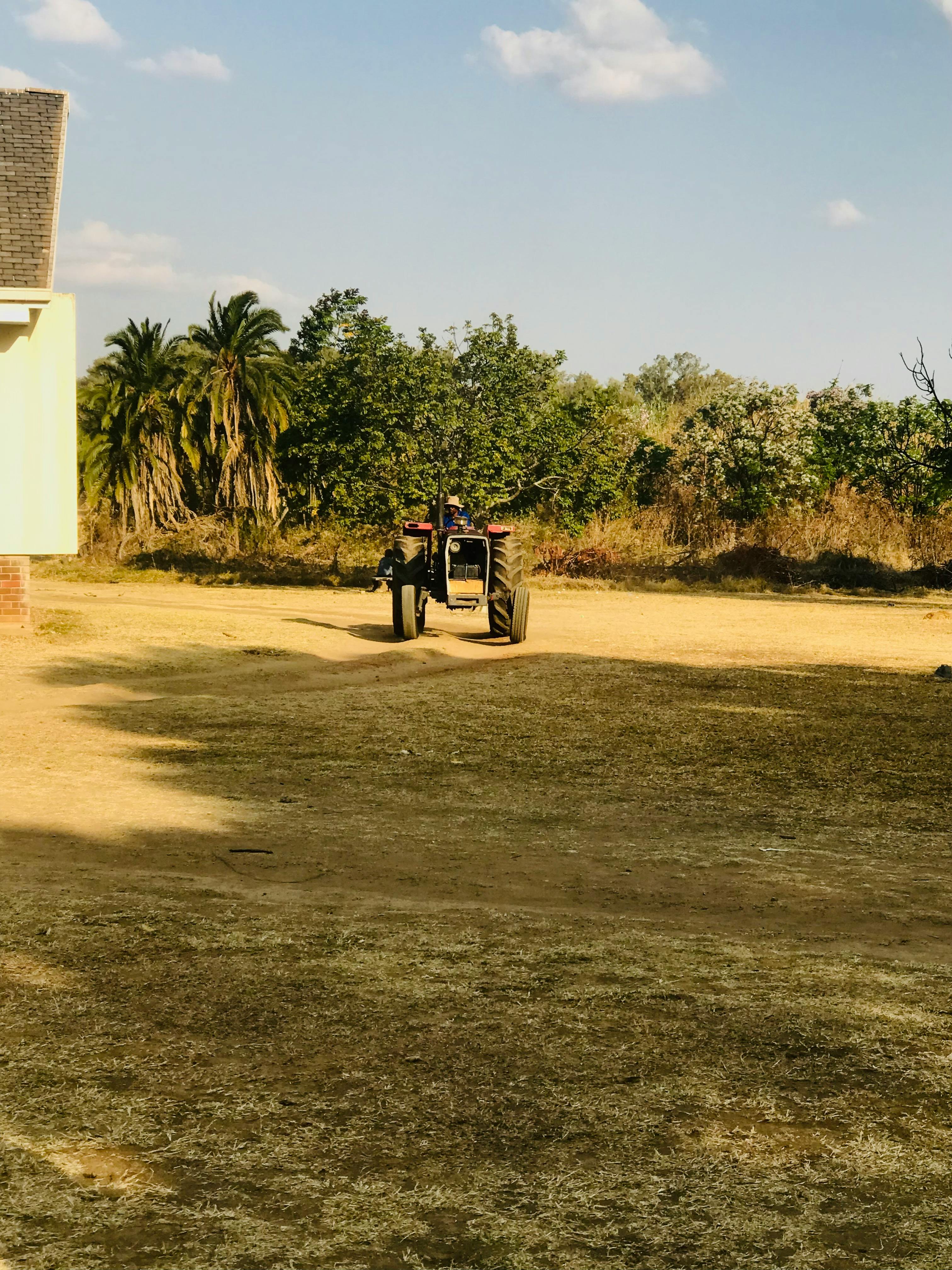 Rural Landscape with Lone Tractor on Farm · Free Stock Photo