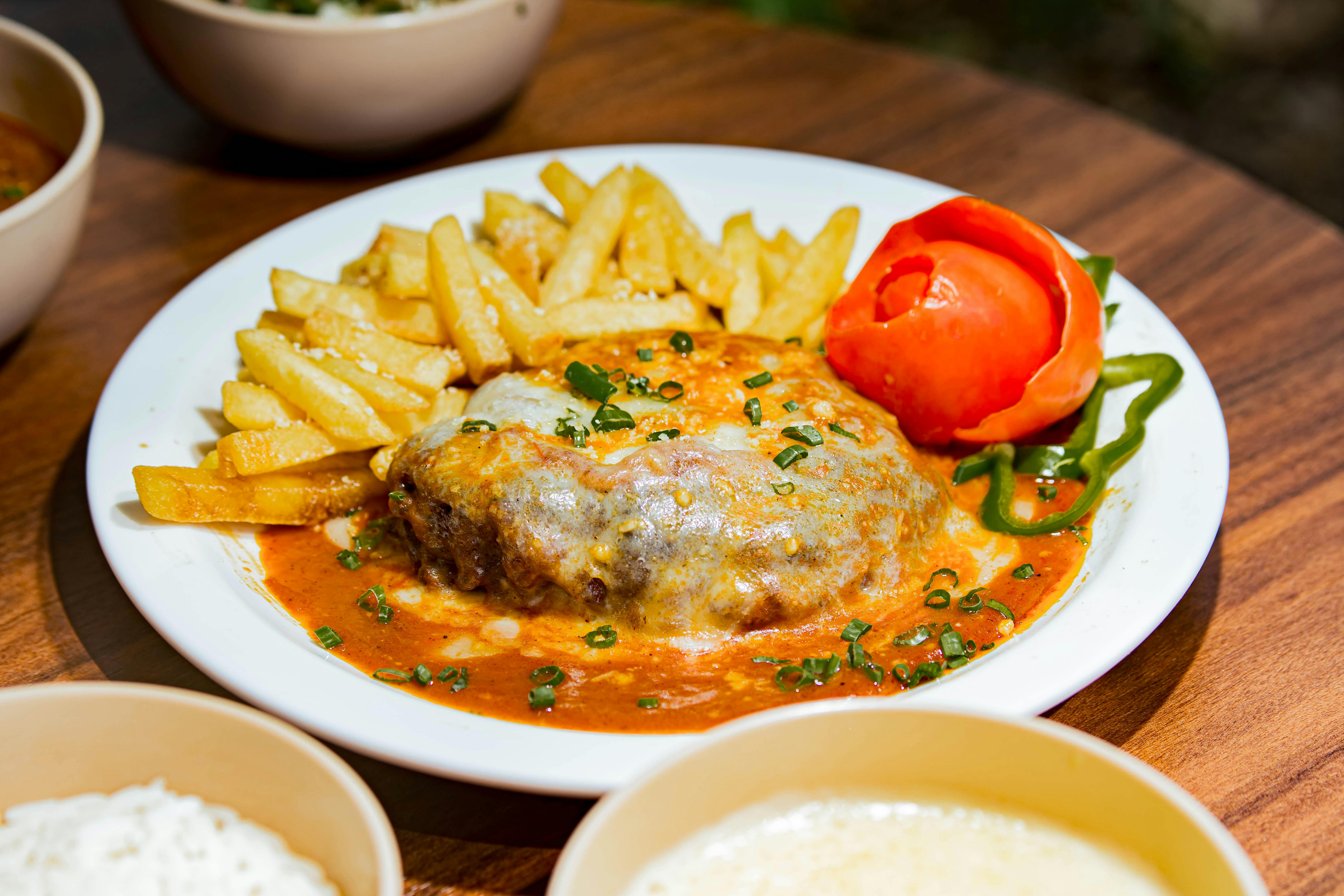 Delicious Cheeseburger Steak with Fries and Tomato Garnish · Free Stock ...