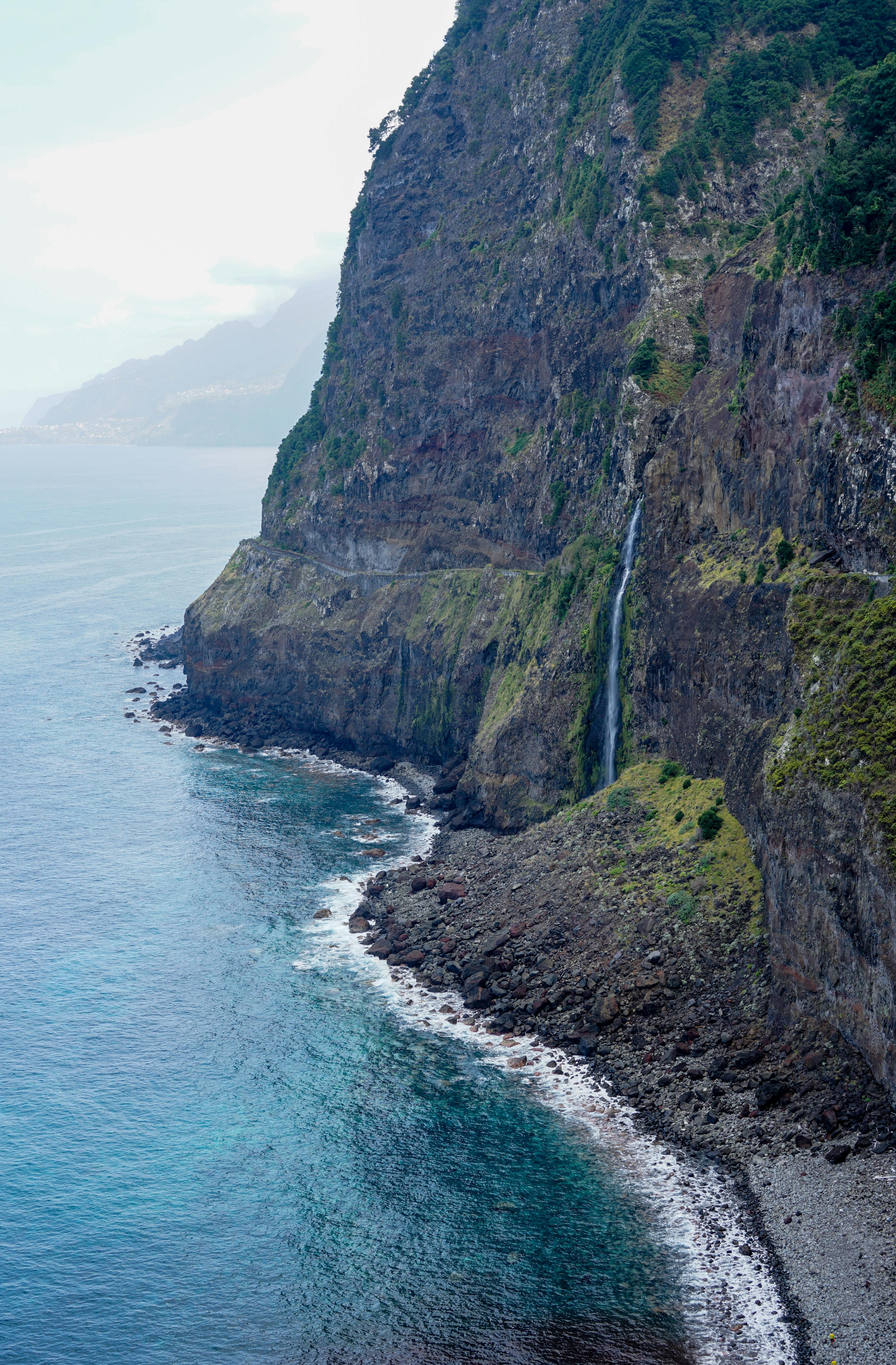 Majestic Cliffside Waterfall by Ocean · Free Stock Photo