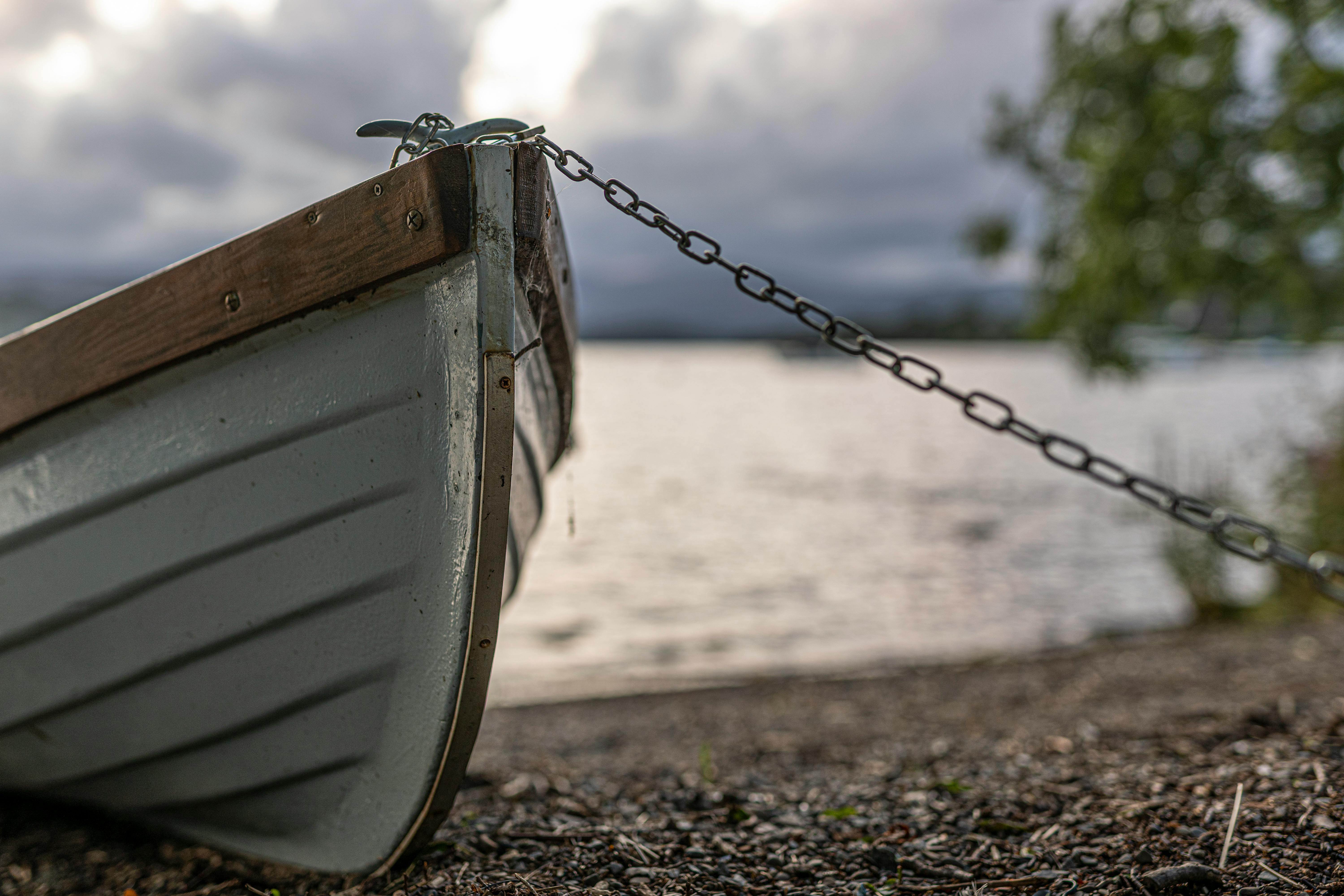 Close-Up Photo of a Chain Attached to a Wooden Boat · Free Stock Photo