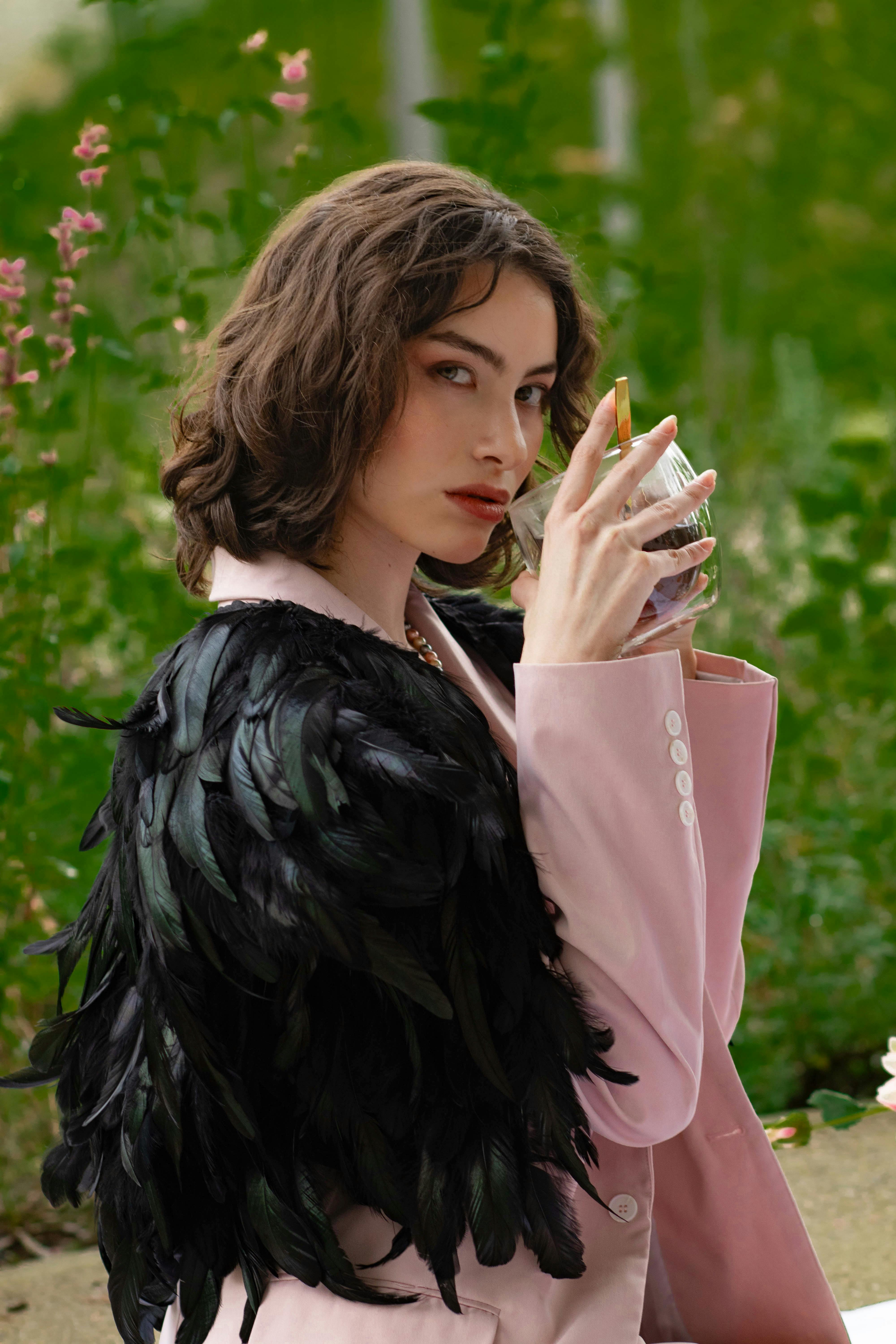 Elegant Woman in Feathered Jacket Outdoors · Free Stock Photo