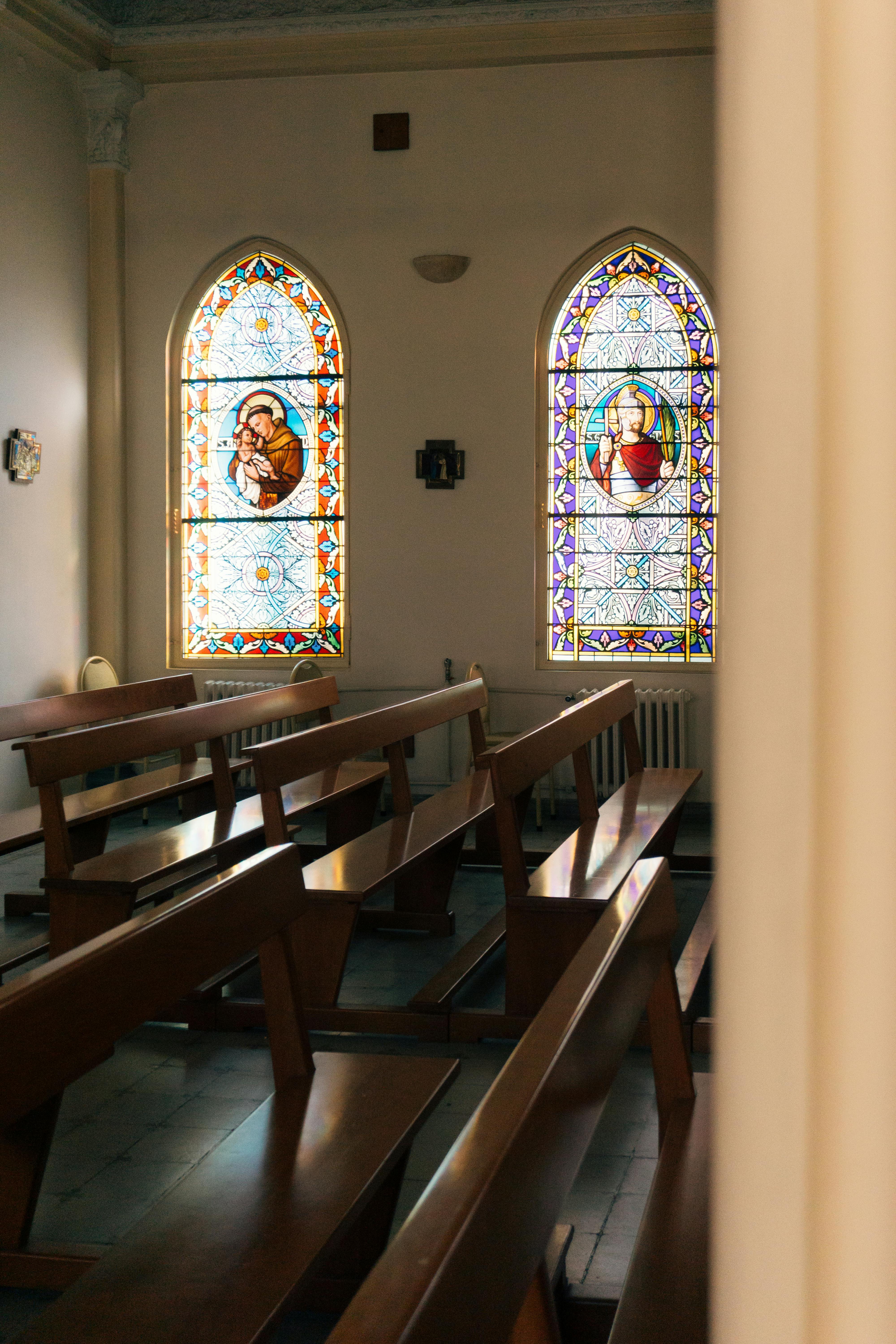 Peaceful church interior with stained glass windows · Free Stock Photo