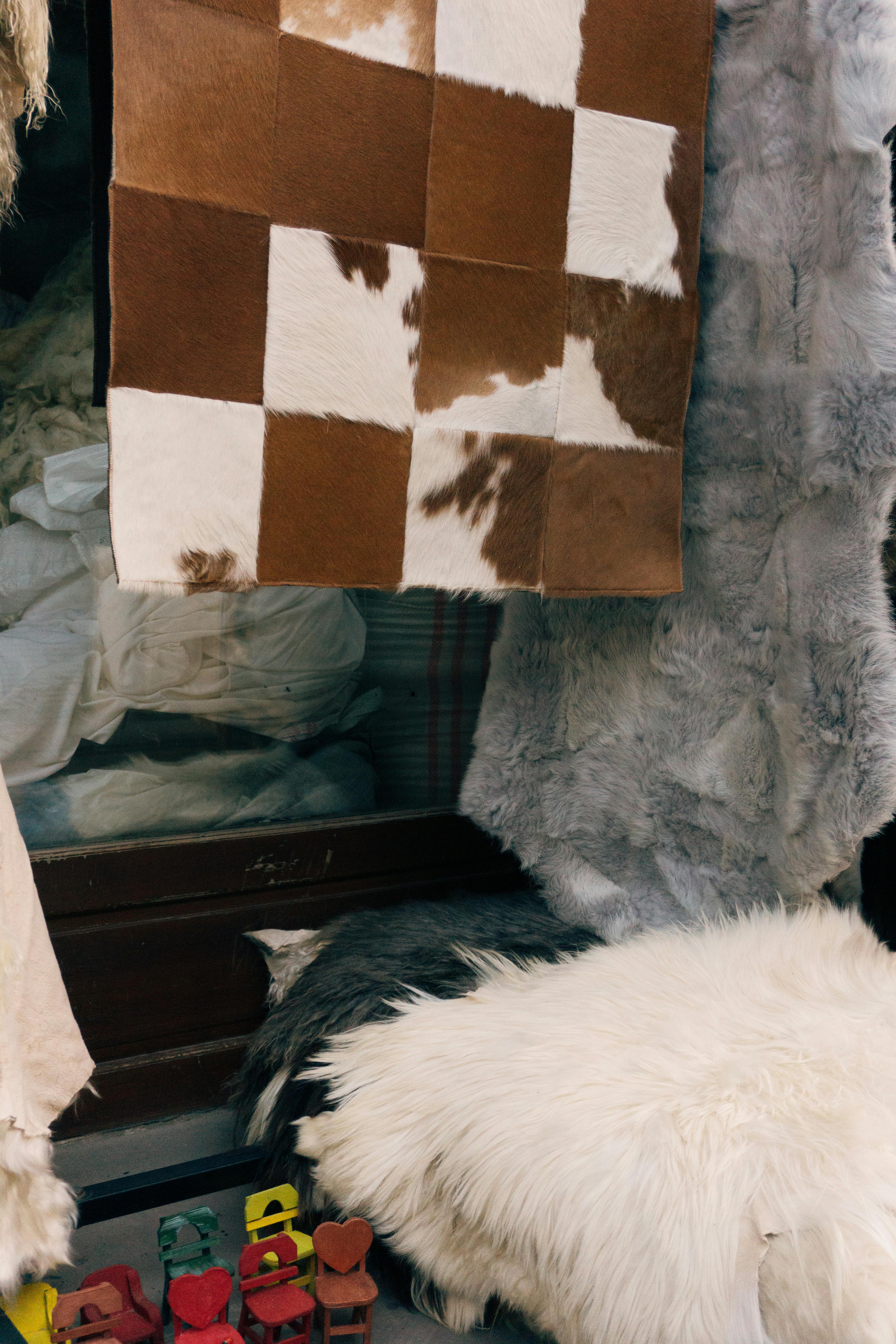 Textured Fur Rugs Display in Cozy Setting · Free Stock Photo