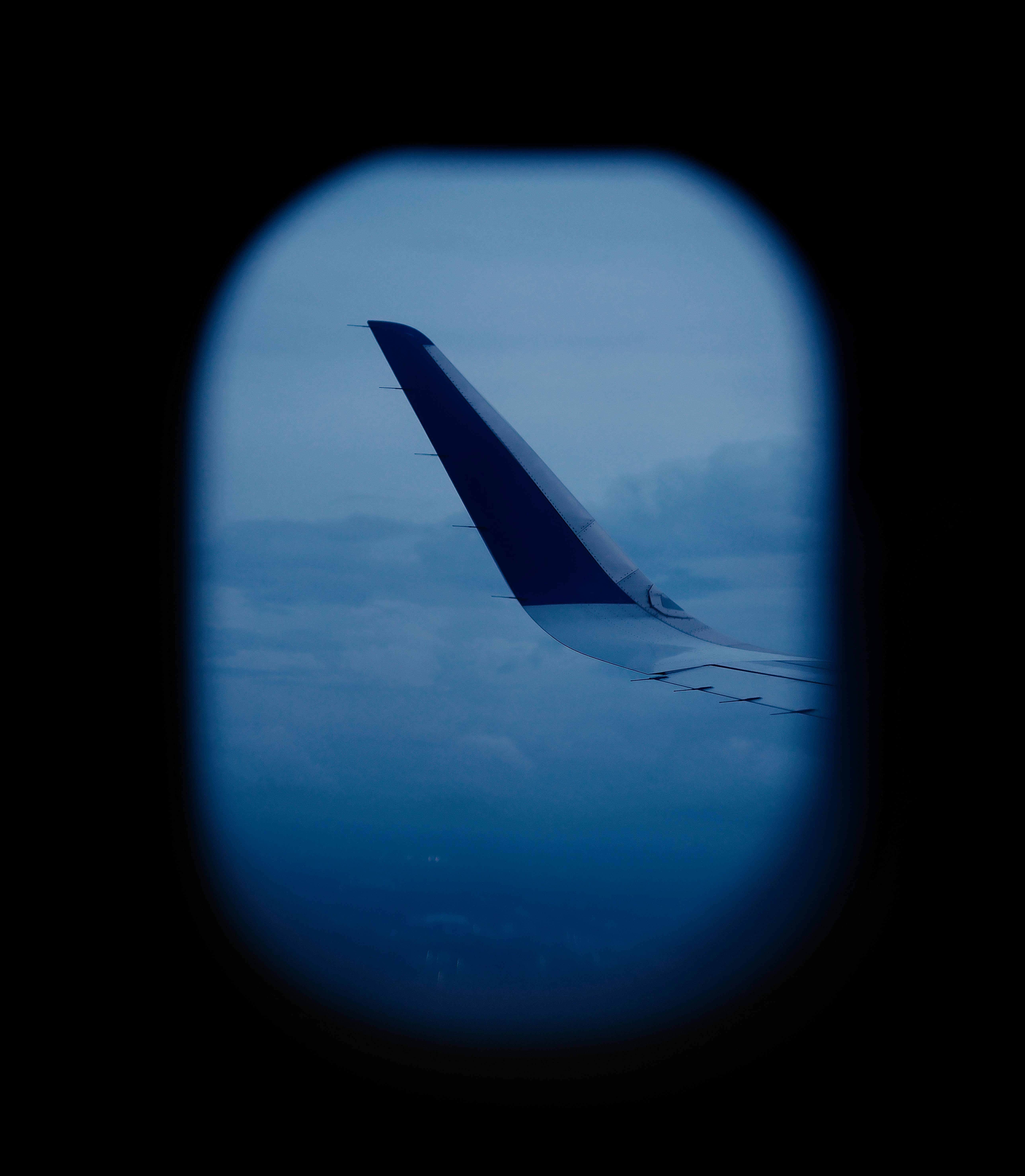 Aerial View of Airplane Wing Through Window · Free Stock Photo