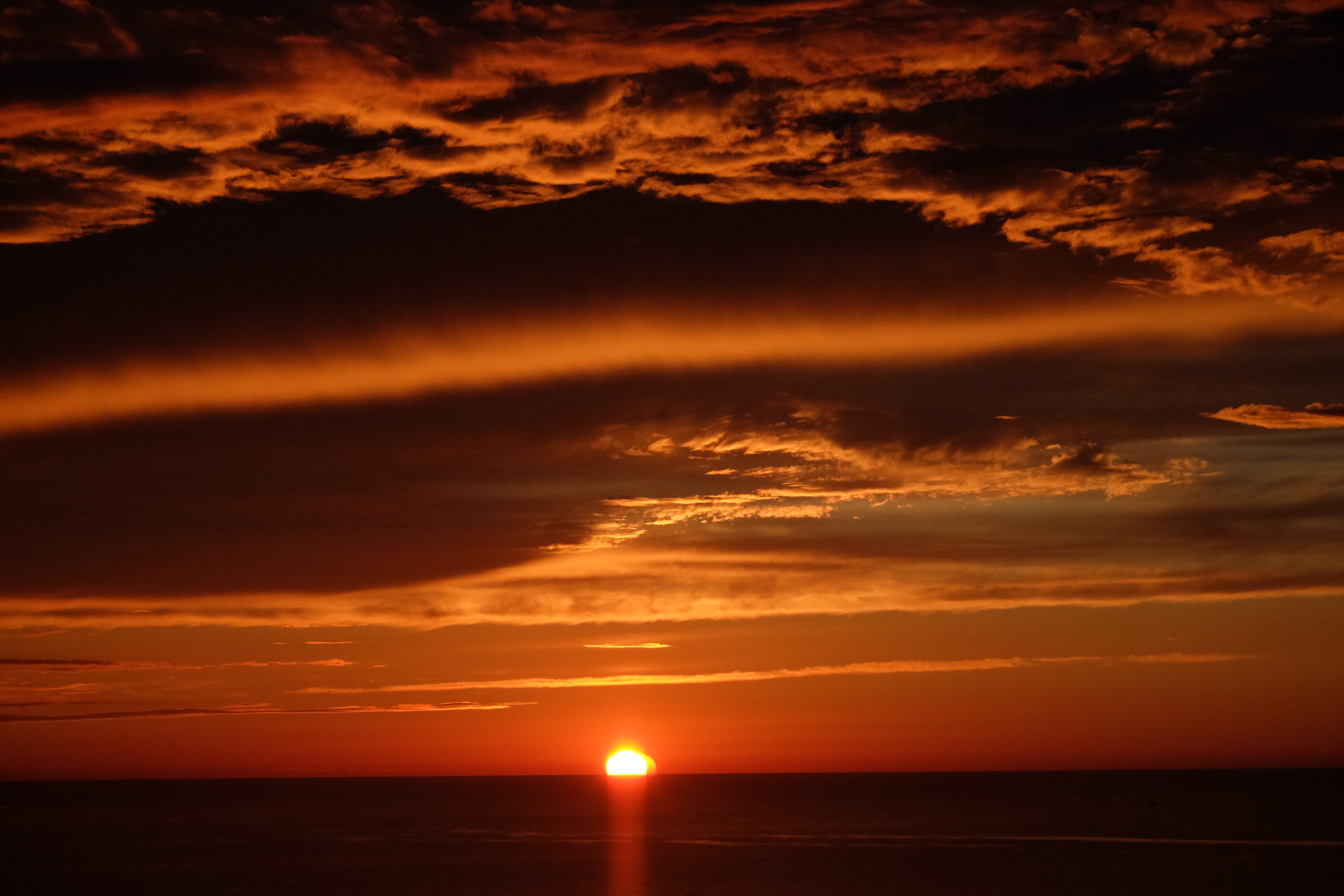 Dramatic Red Sunset Over Ocean Horizon · Free Stock Photo
