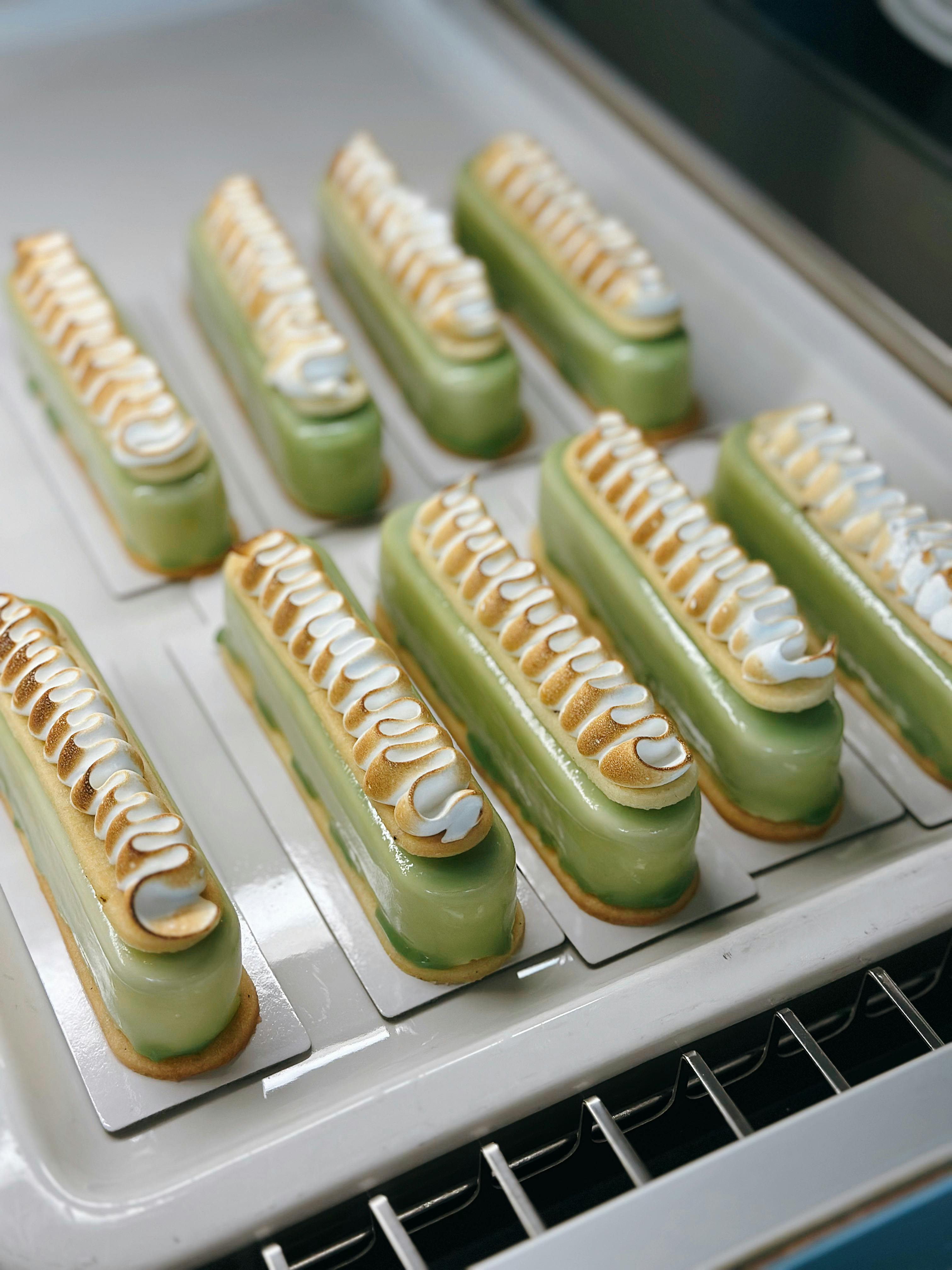 Delicious Green Pistachio Eclairs on Baking Tray · Free Stock Photo