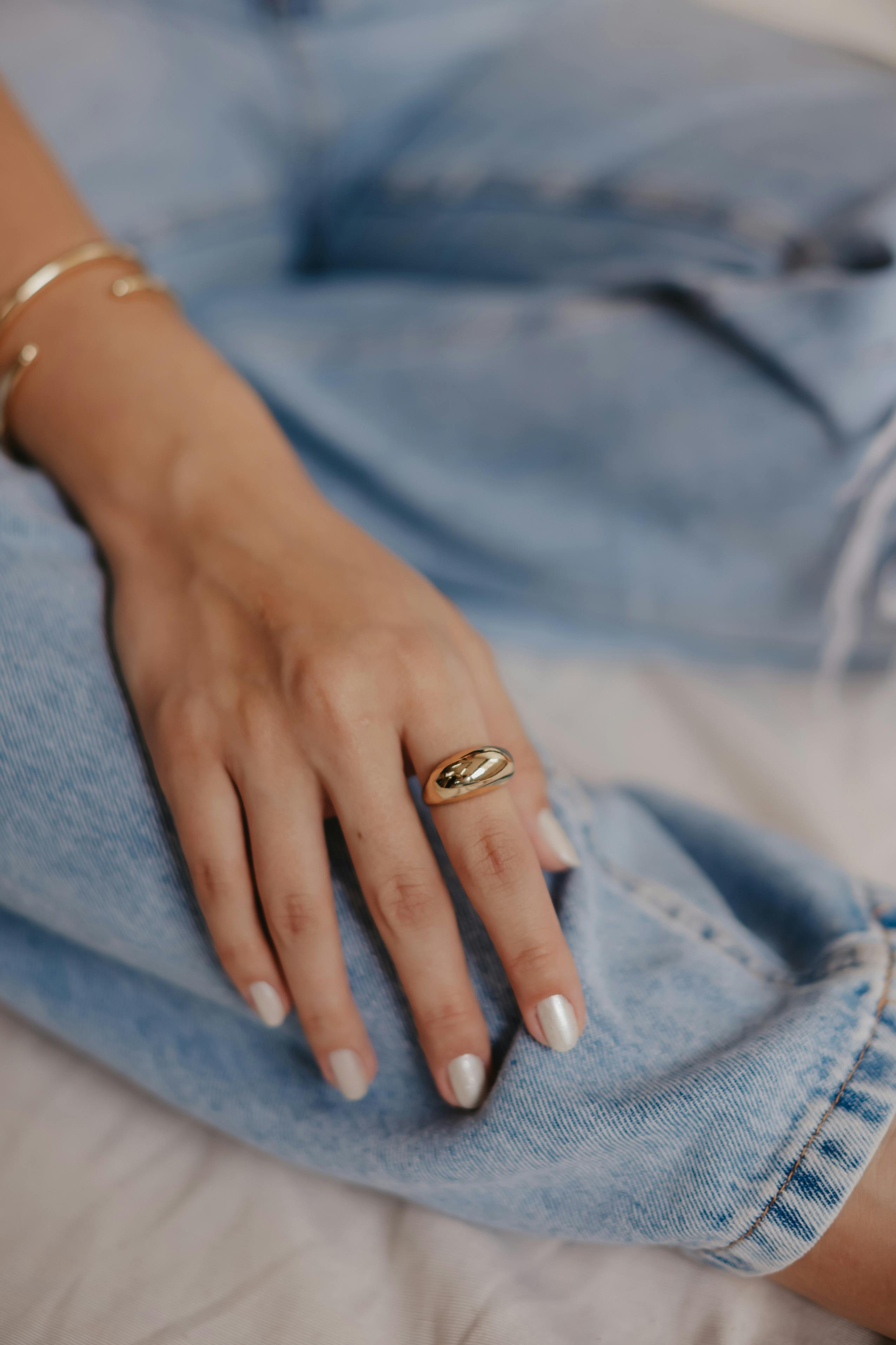 Close-up of Hand with Gold Ring on Denim · Free Stock Photo