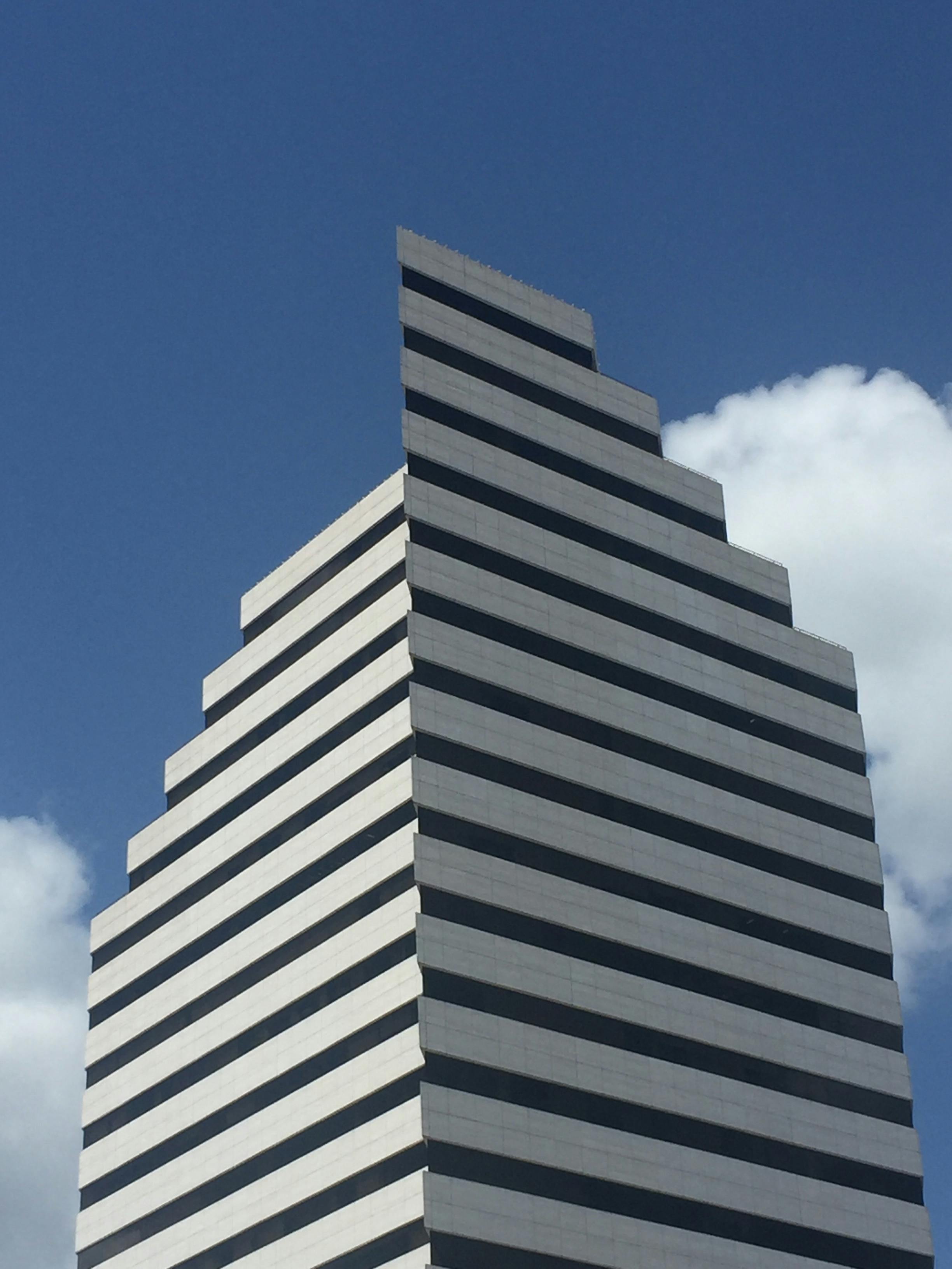 Modern Geometric Skyscraper Against Blue Sky · Free Stock Photo