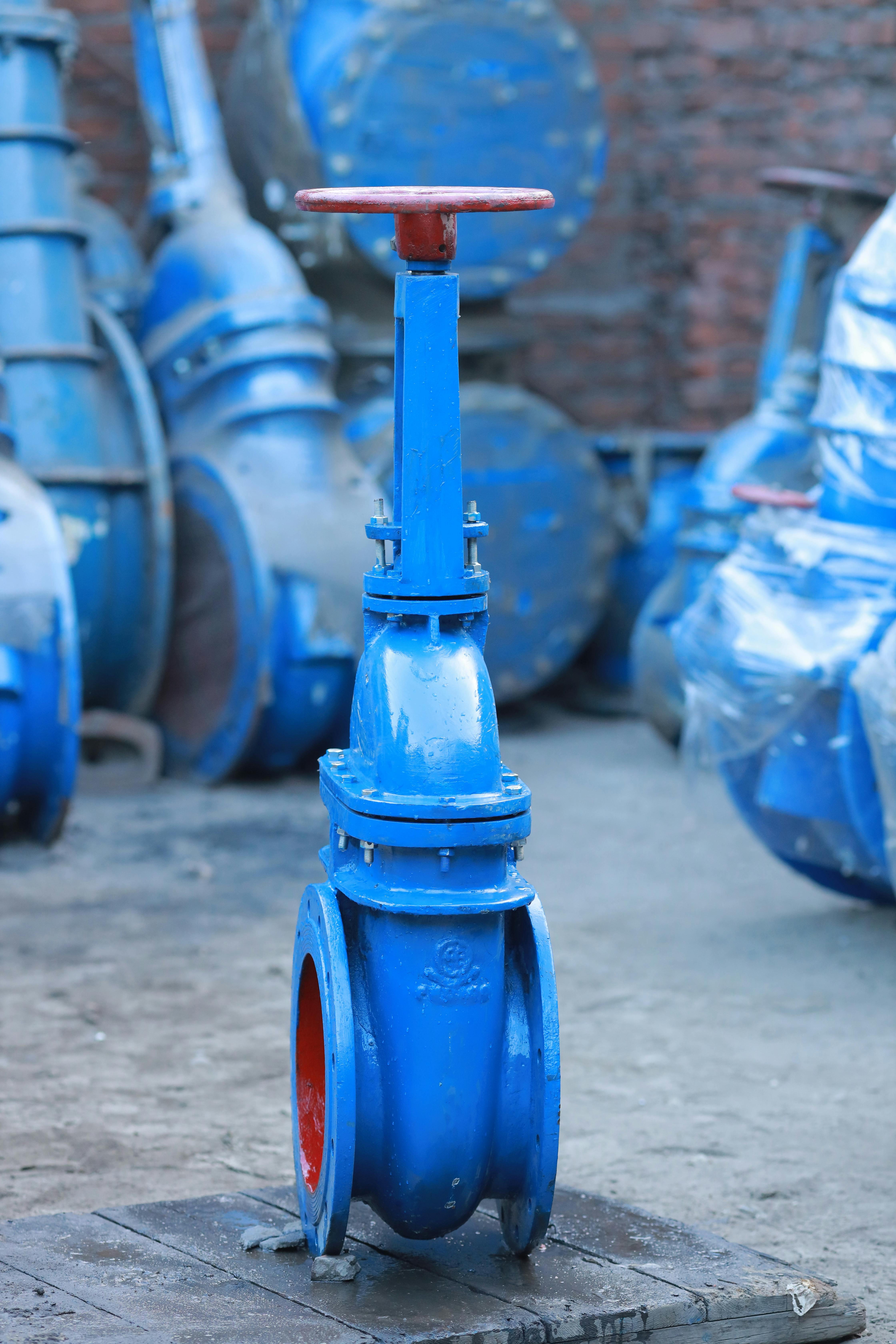 Industrial Blue Metal Valve in Warehouse Setting · Free Stock Photo