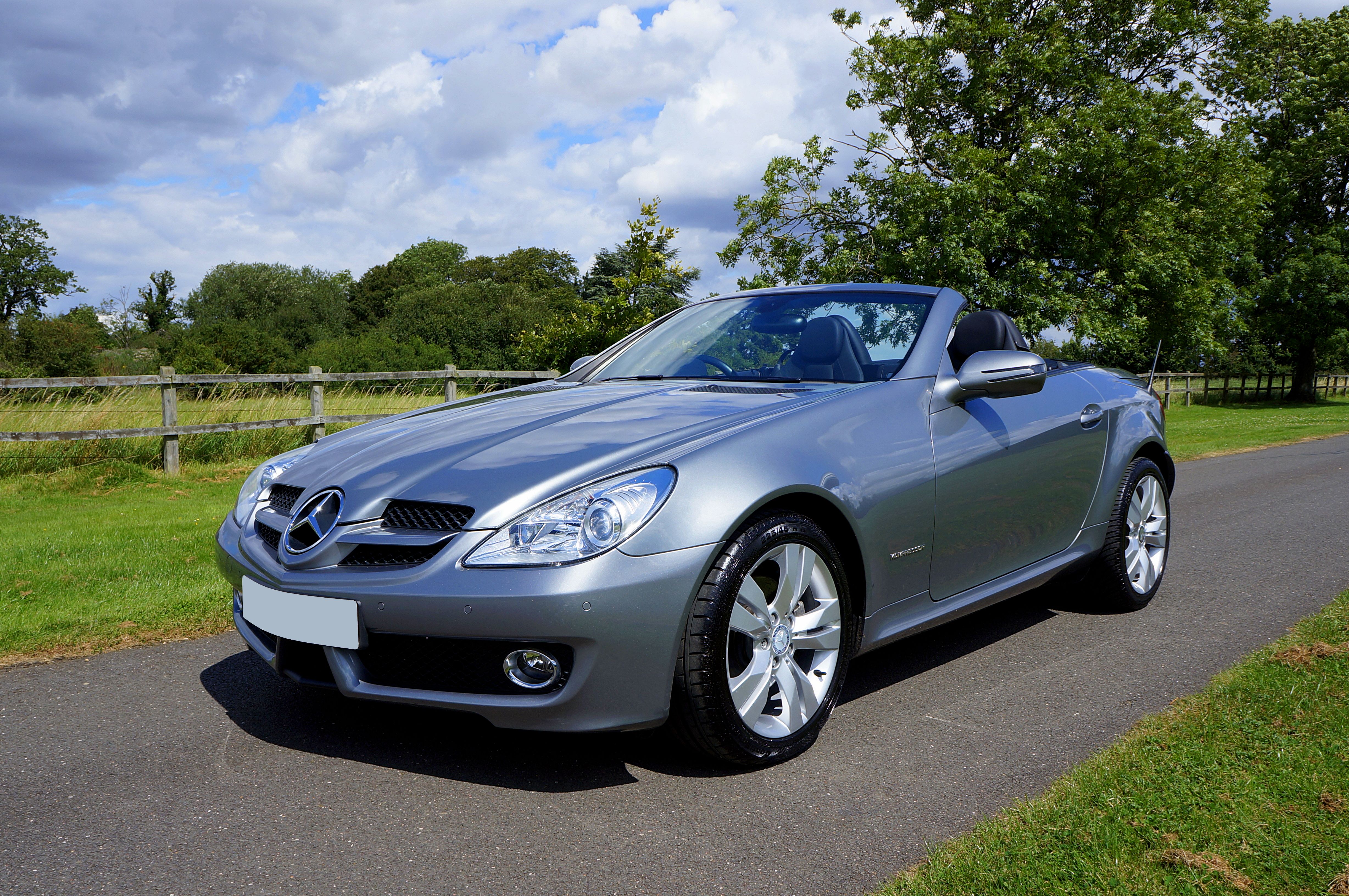 Sleek Silver Convertible on a Scenic Road · Free Stock Photo