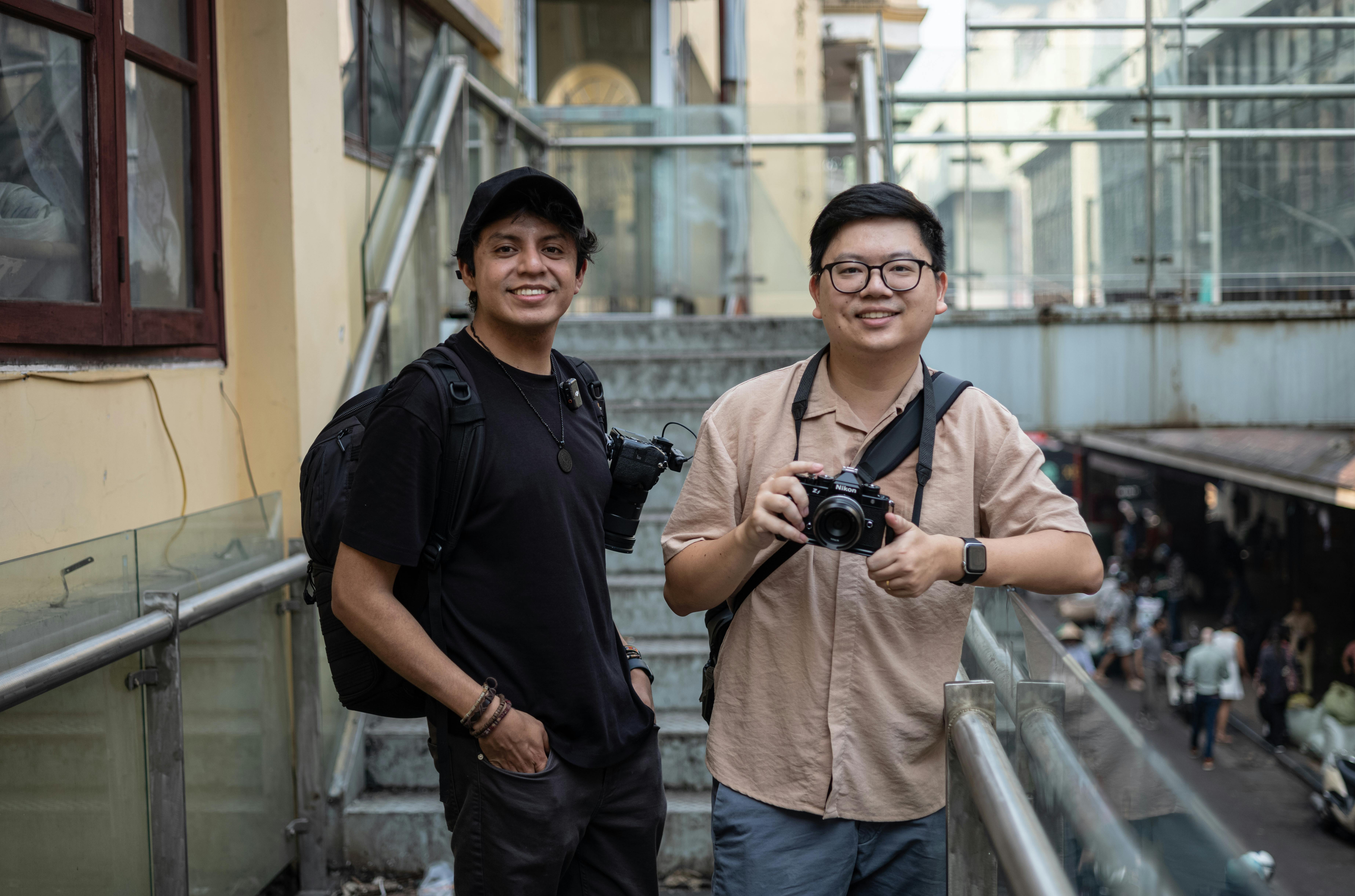 Urban Photographers Exploring a Cityscape · Free Stock Photo