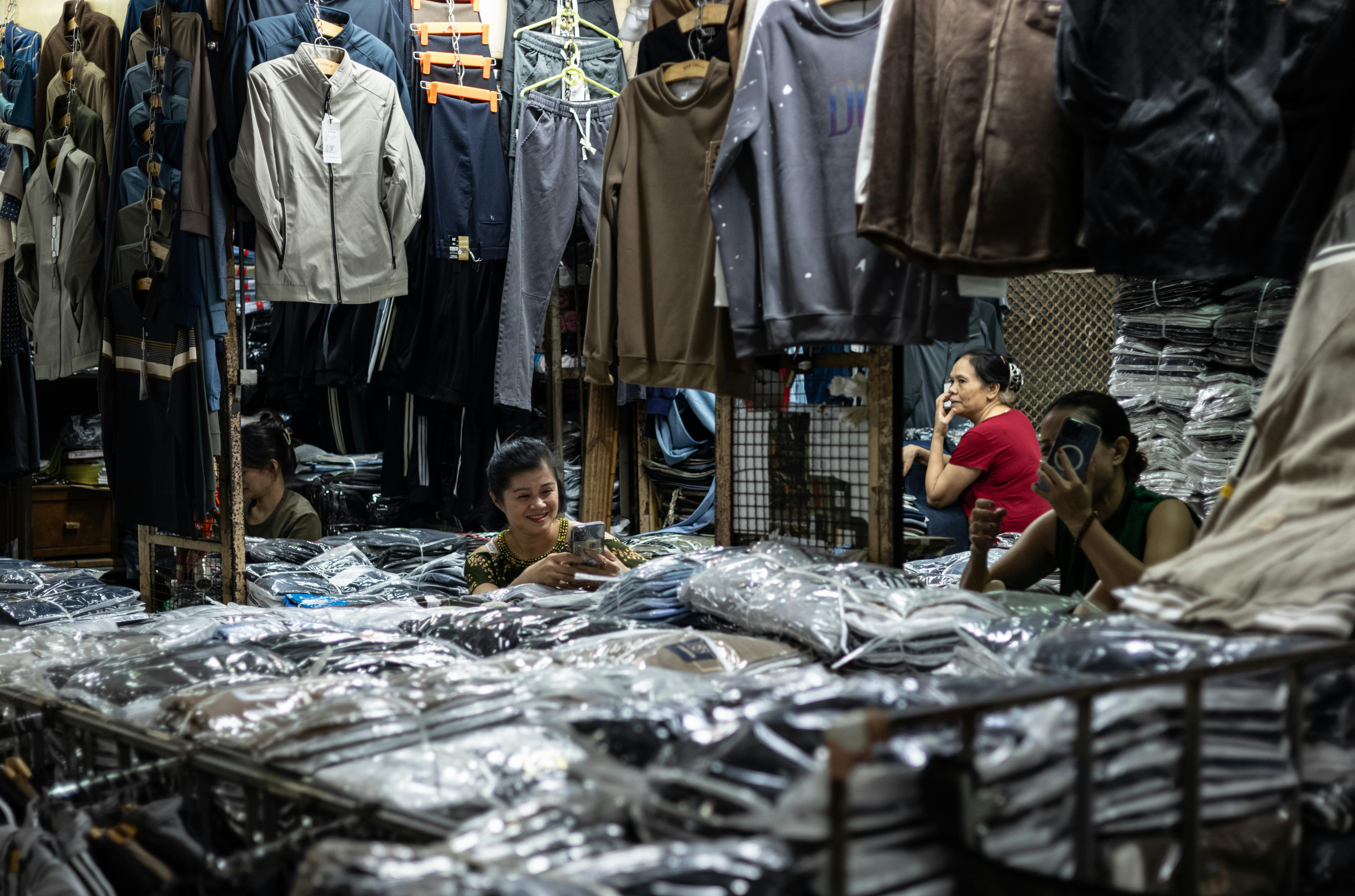 Busy Clothing Store with Workers and Merchandise · Free Stock Photo