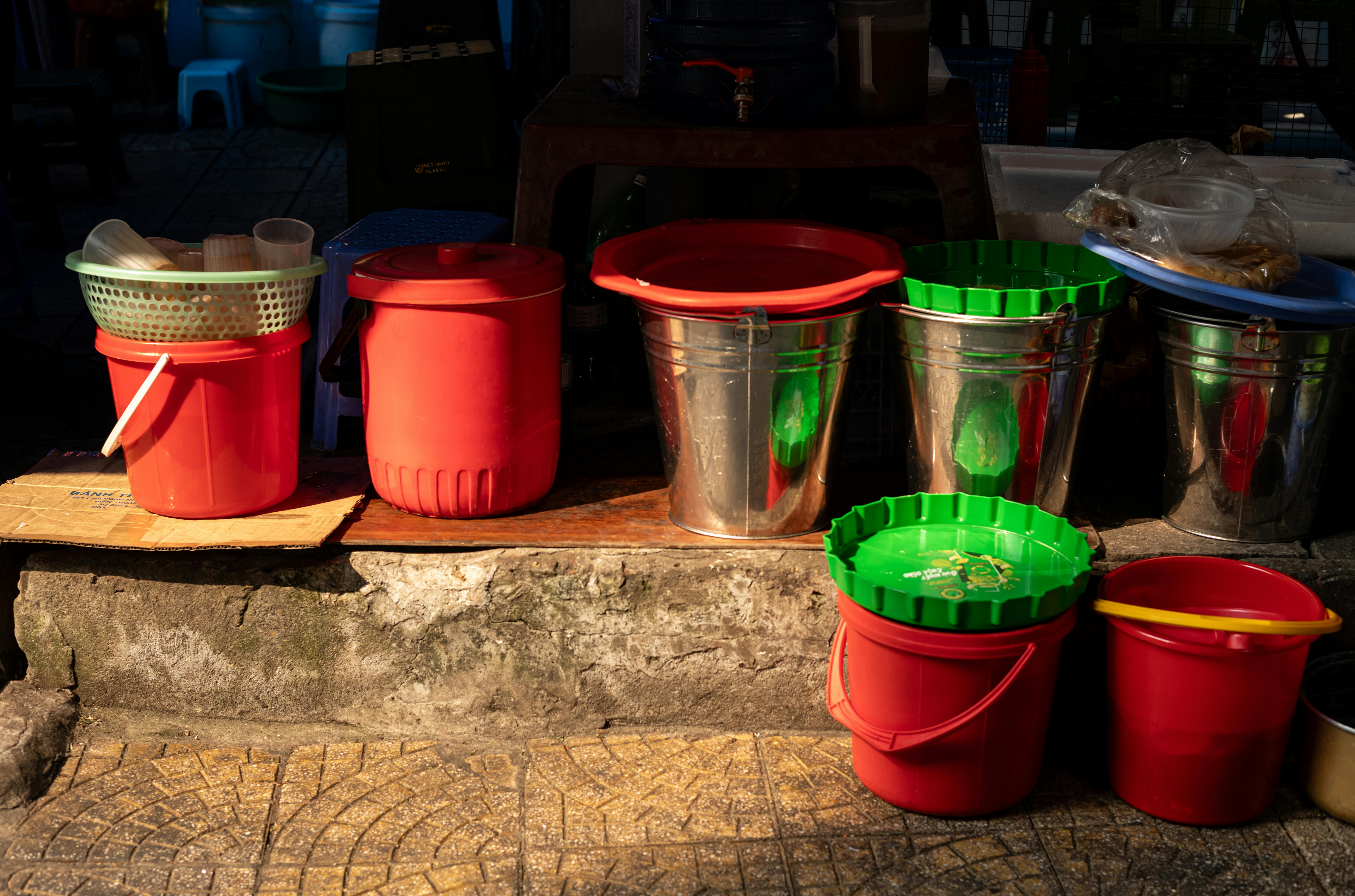 Colorful Plastic and Metal Buckets in Sunlight · Free Stock Photo