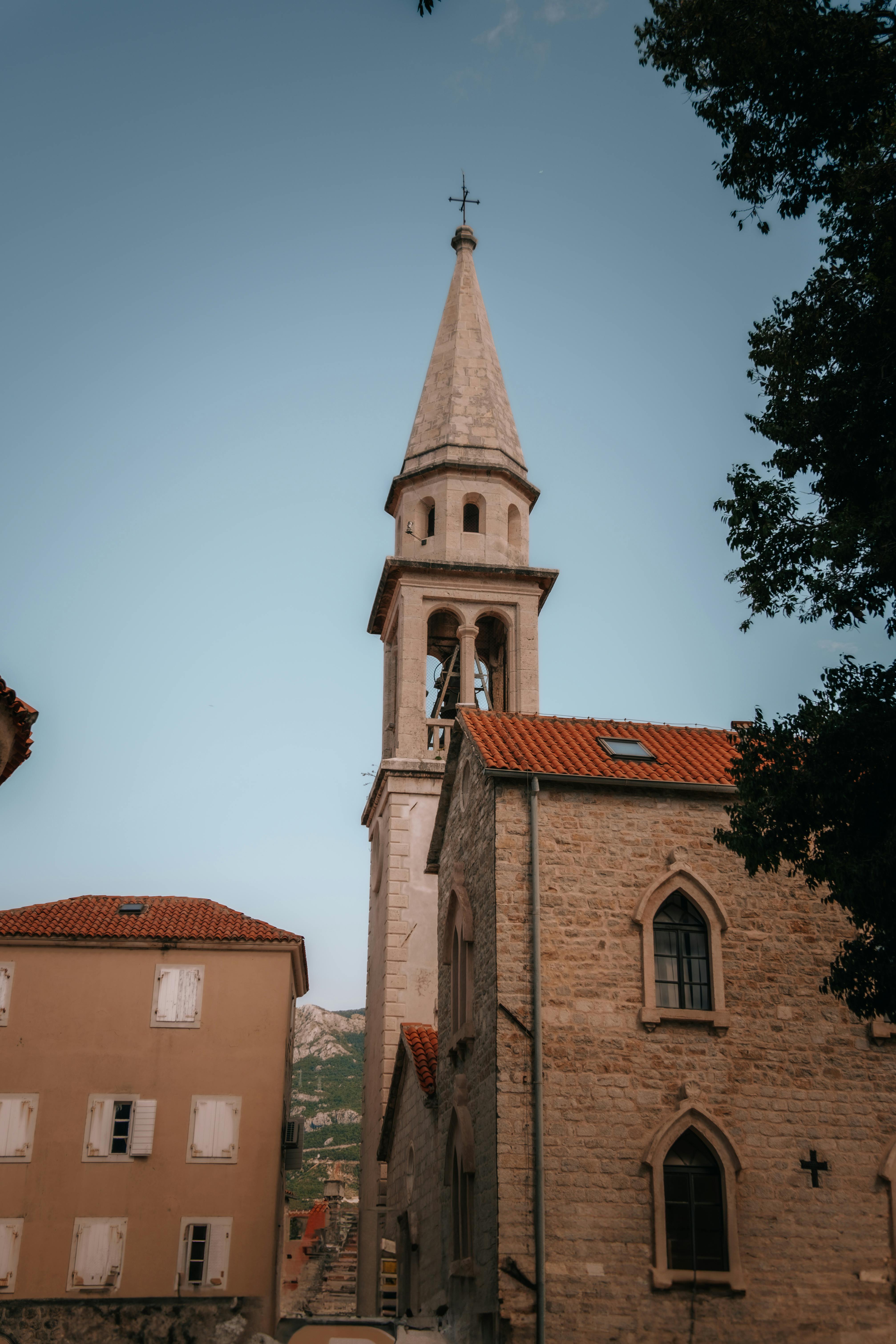 Historic Church Spire in Picturesque European Town · Free Stock Photo