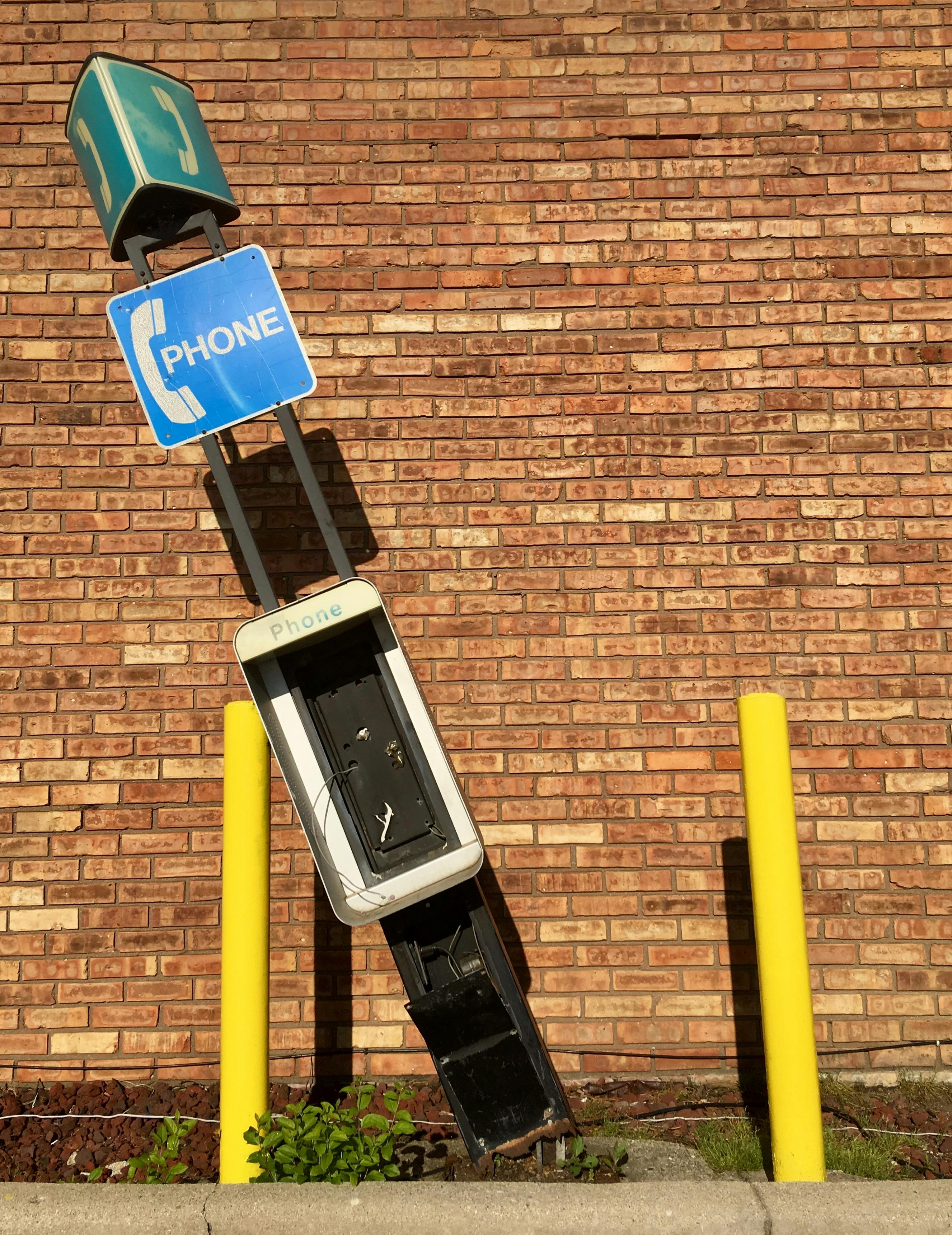 Abandoned Retro Payphone against Brick Wall · Free Stock Photo