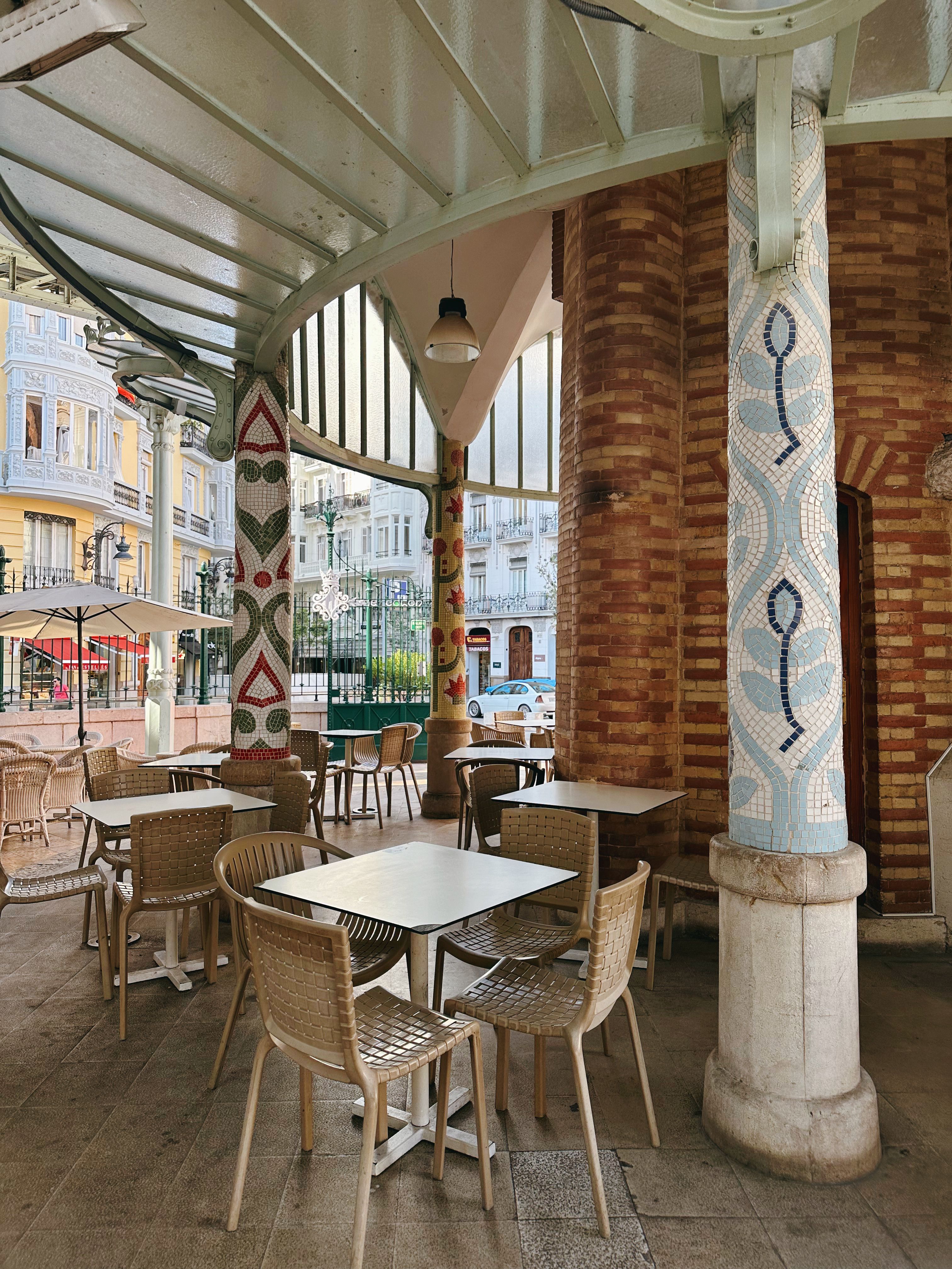 Charming Outdoor Cafe With Mosaic Columns · Free Stock Photo