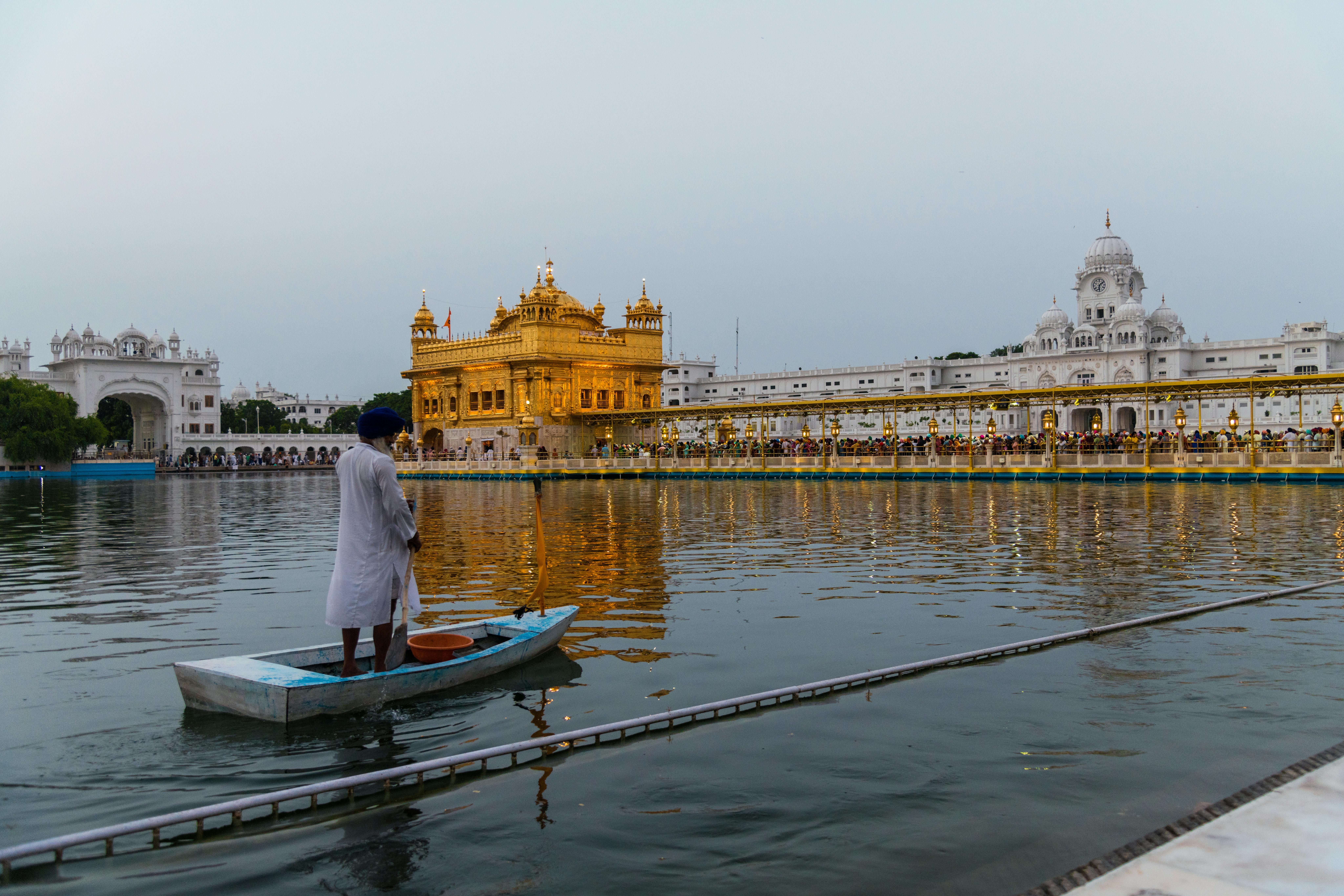 Golden temple near water in evening · Free Stock Photo