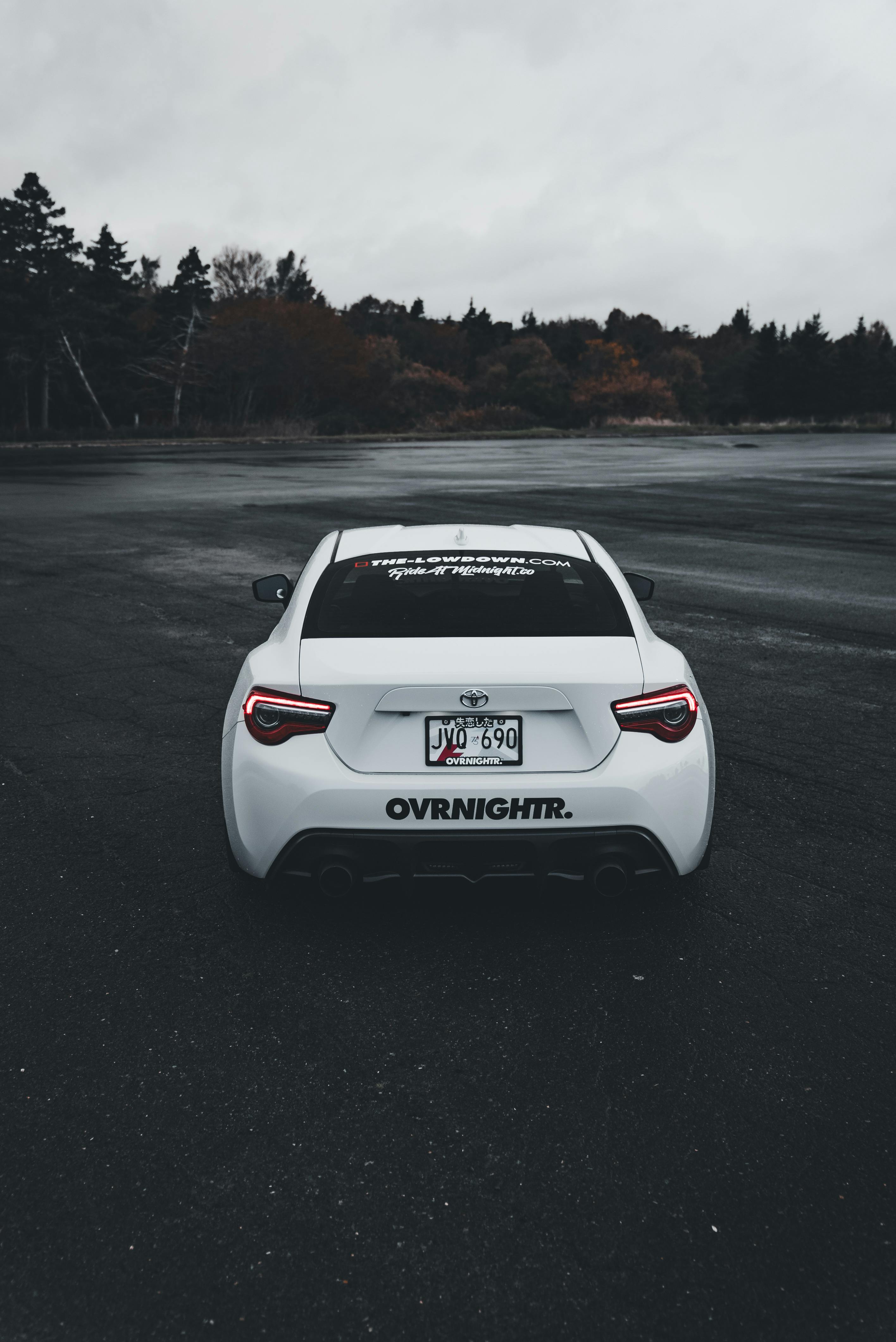 Sporty White Car in Overcast Outdoor Setting · Free Stock Photo