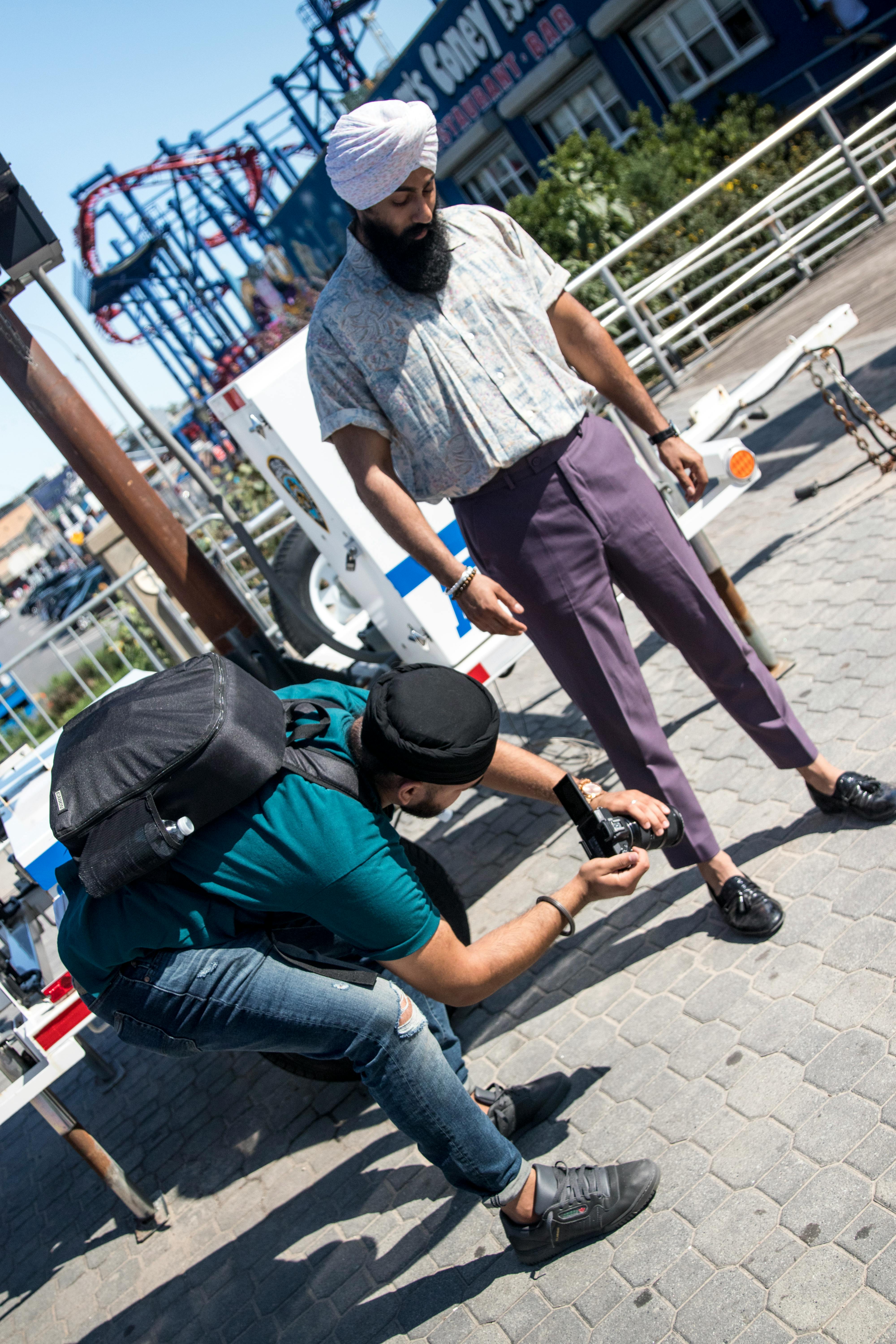 Man Taking Photo of a Man Wearing Purple Pants · Free Stock Photo