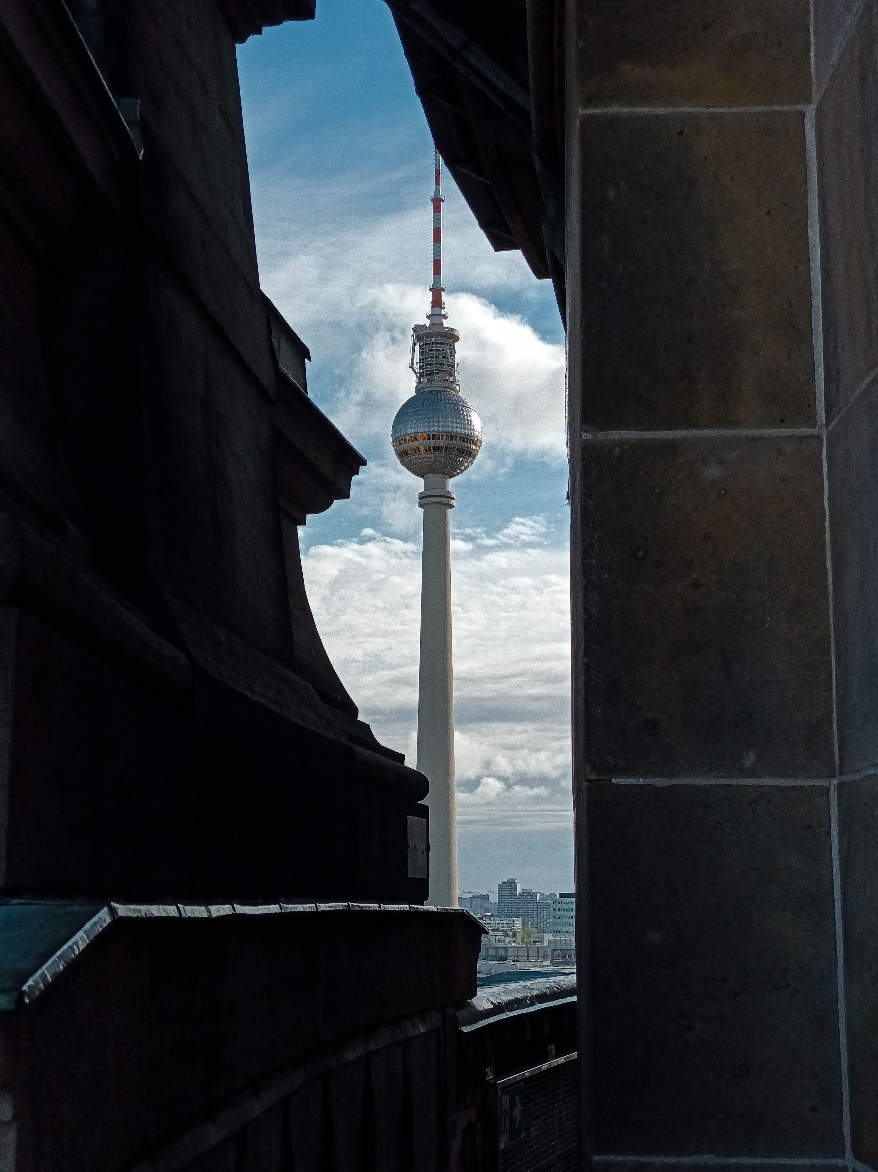 Berlin TV Tower framed by architectural structures · Free Stock Photo