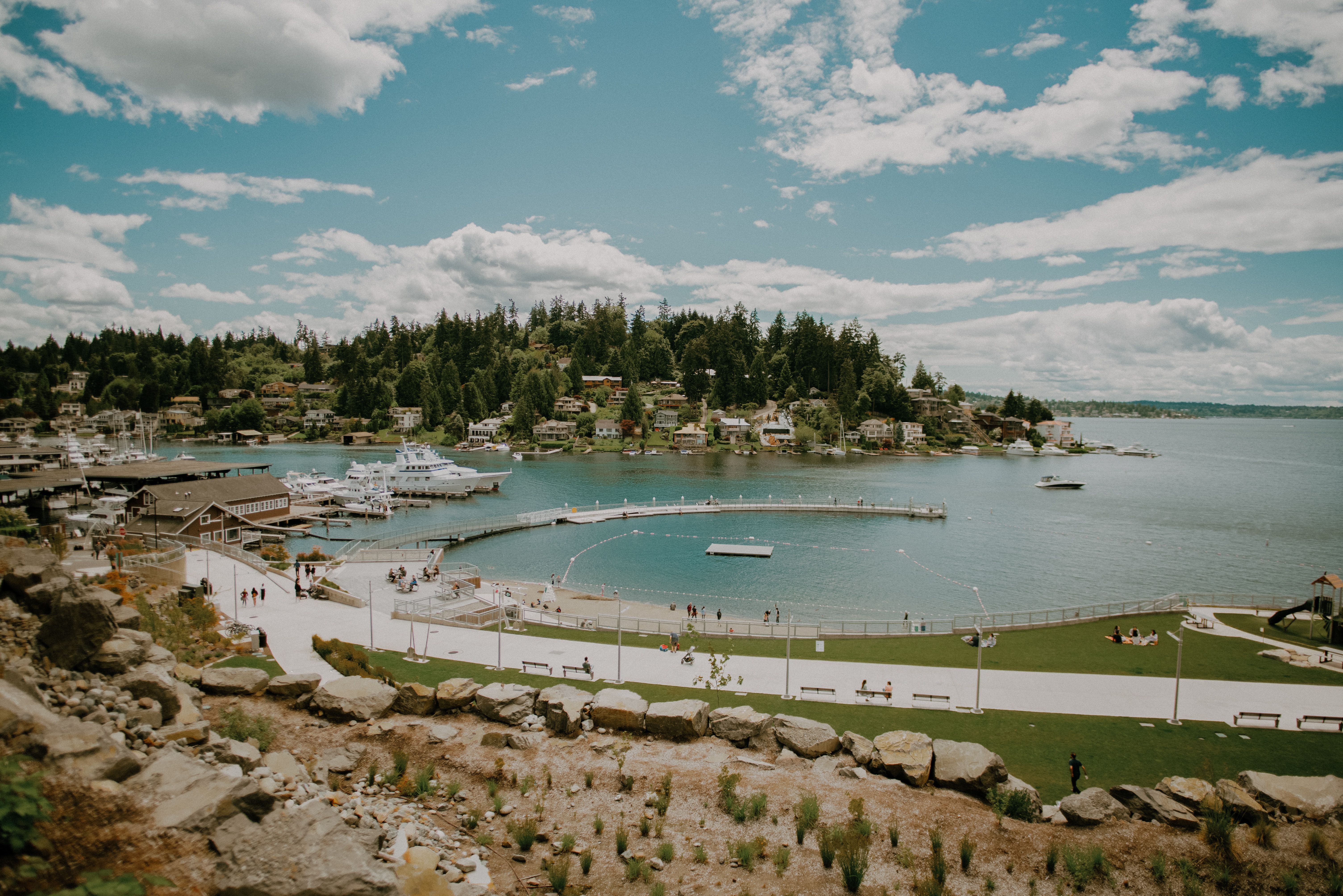 Scenic Bay View with Boats and Waterfront Path · Free Stock Photo