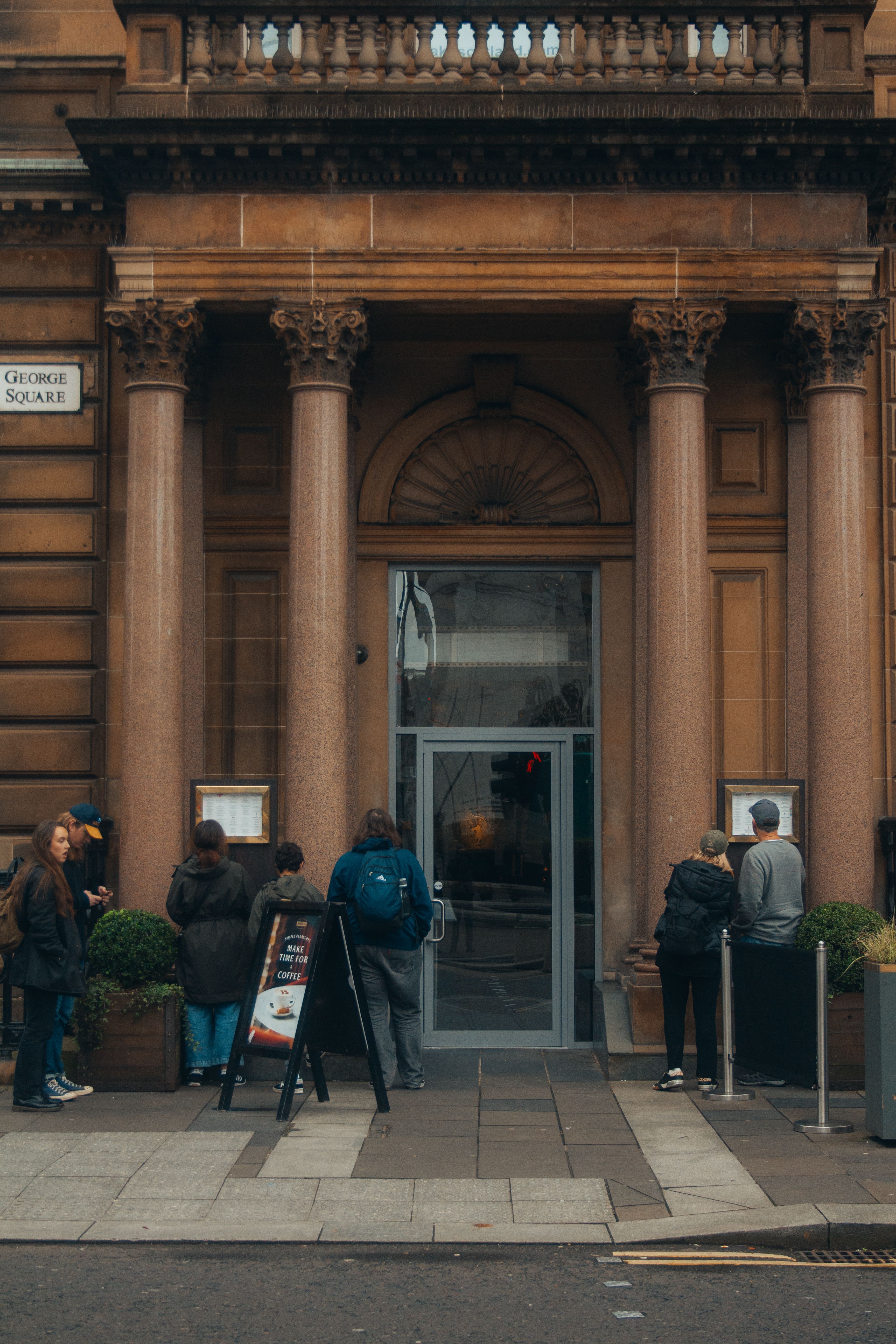 Historic Building Facade with Waiting Crowd · Free Stock Photo