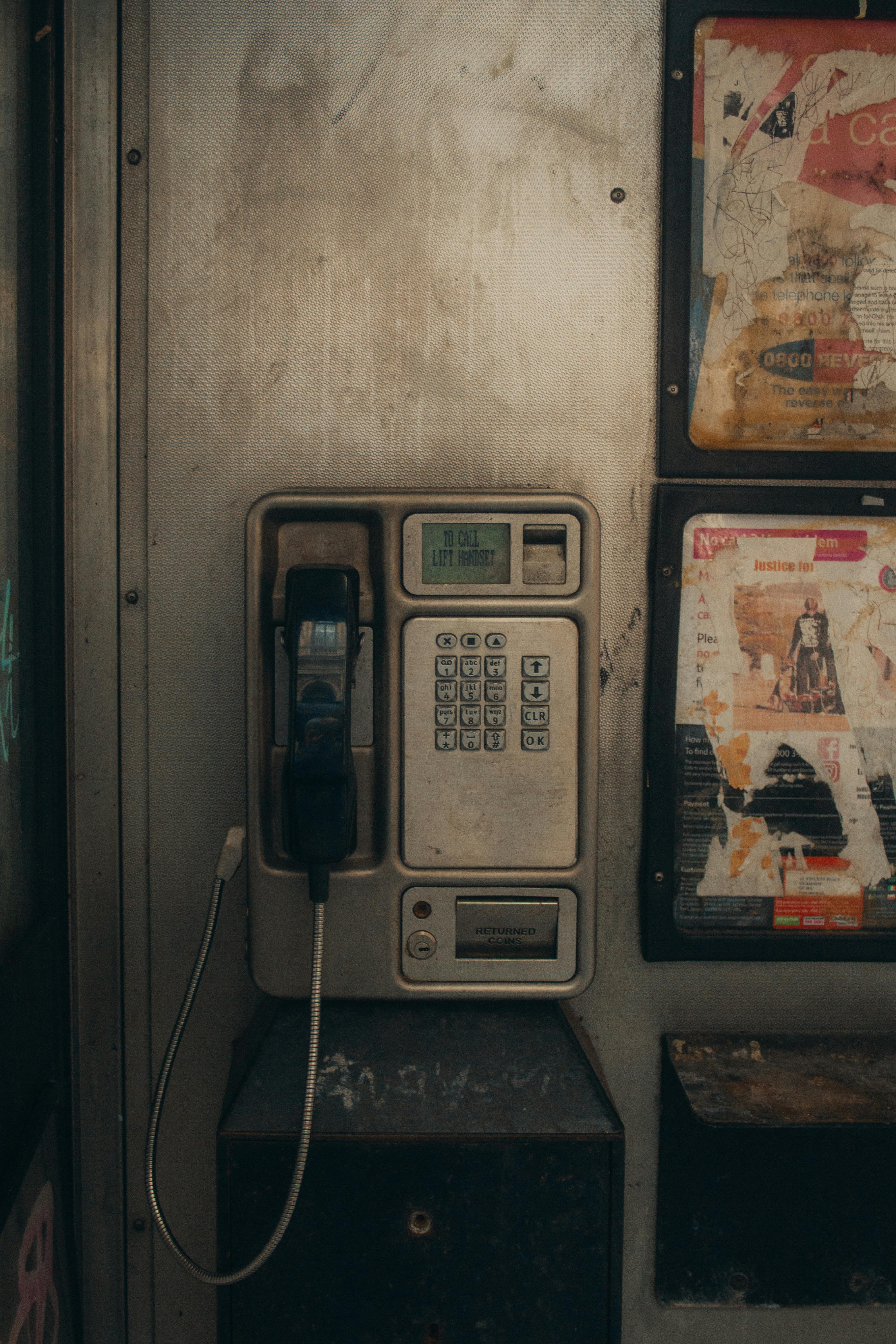 Old metal public payphone hanging on shabby wall · Free Stock Photo