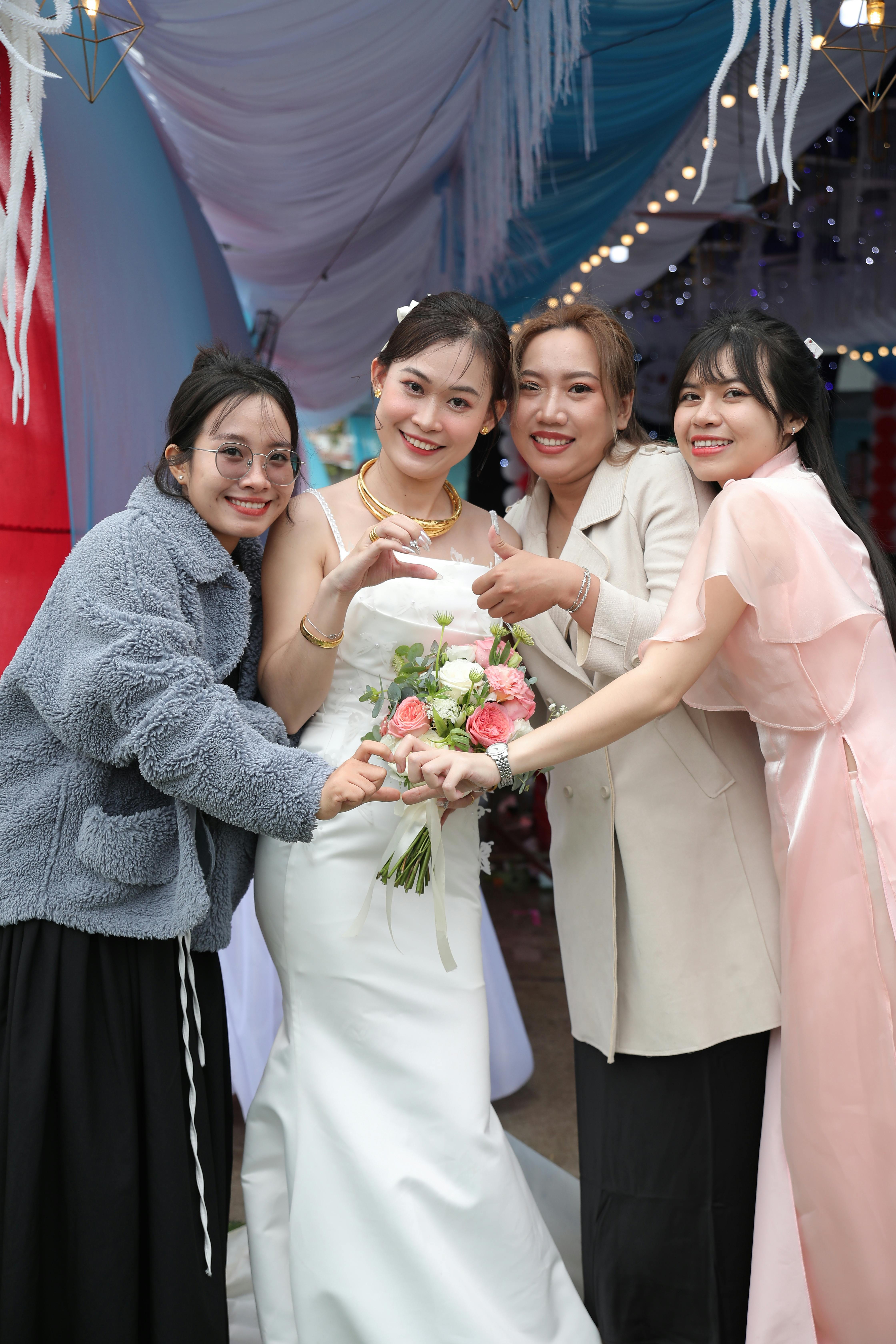 Joyful Wedding Celebration with Bride and Friends · Free Stock Photo