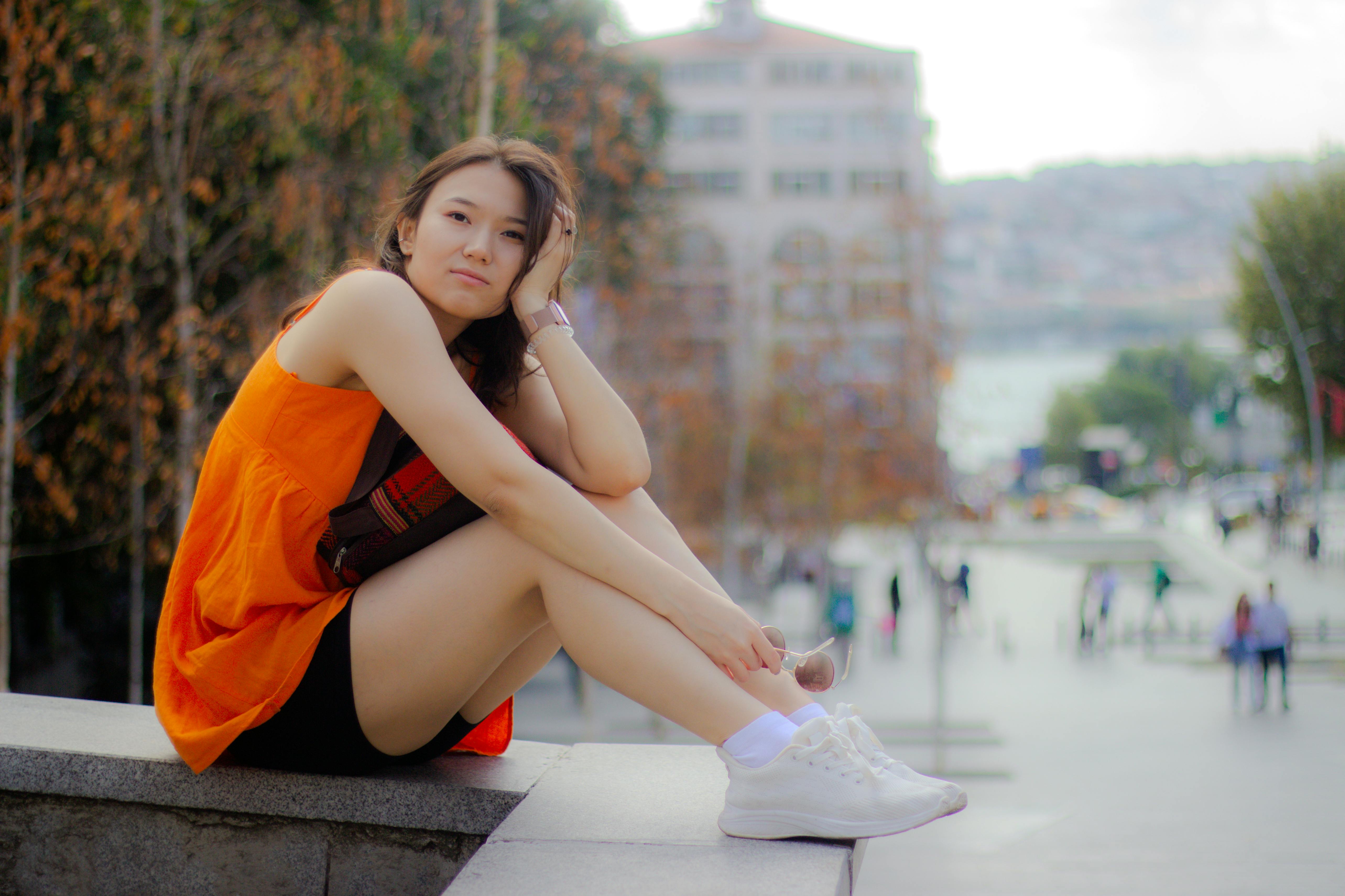 Young Woman Relaxing in Cityscape · Free Stock Photo