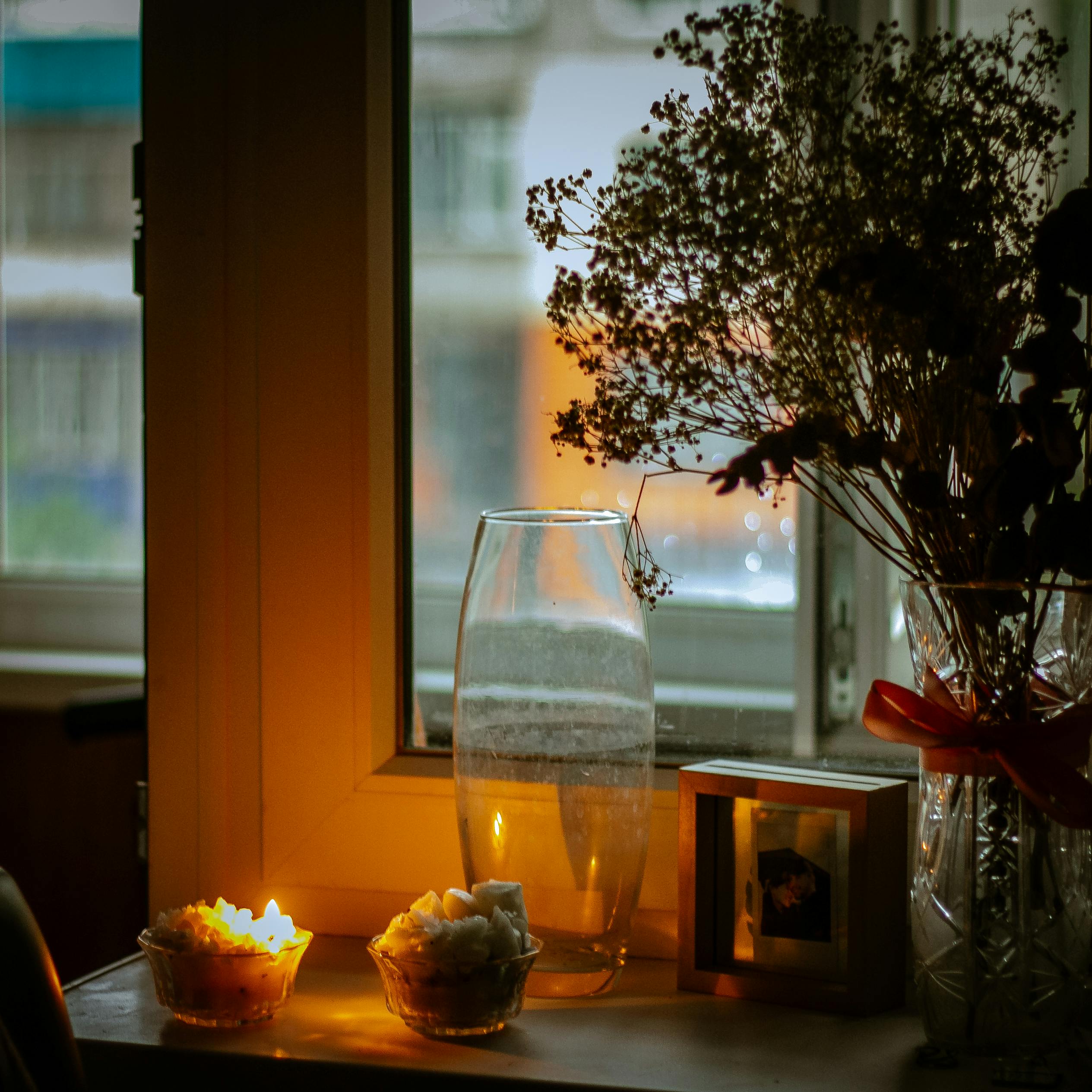 Cozy Indoor Candlelit Scene by a Window · Free Stock Photo