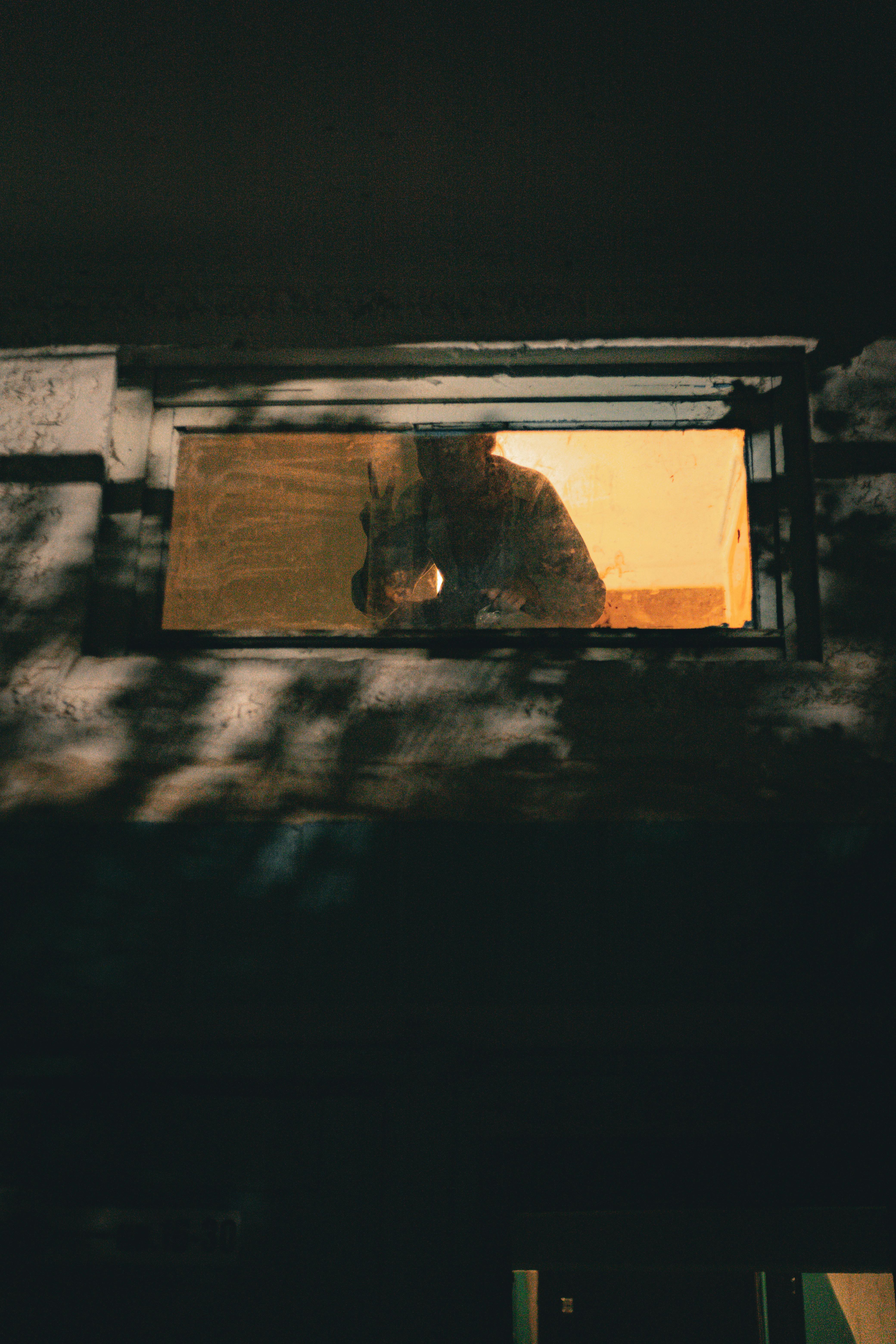Mysterious silhouette in window during night · Free Stock Photo
