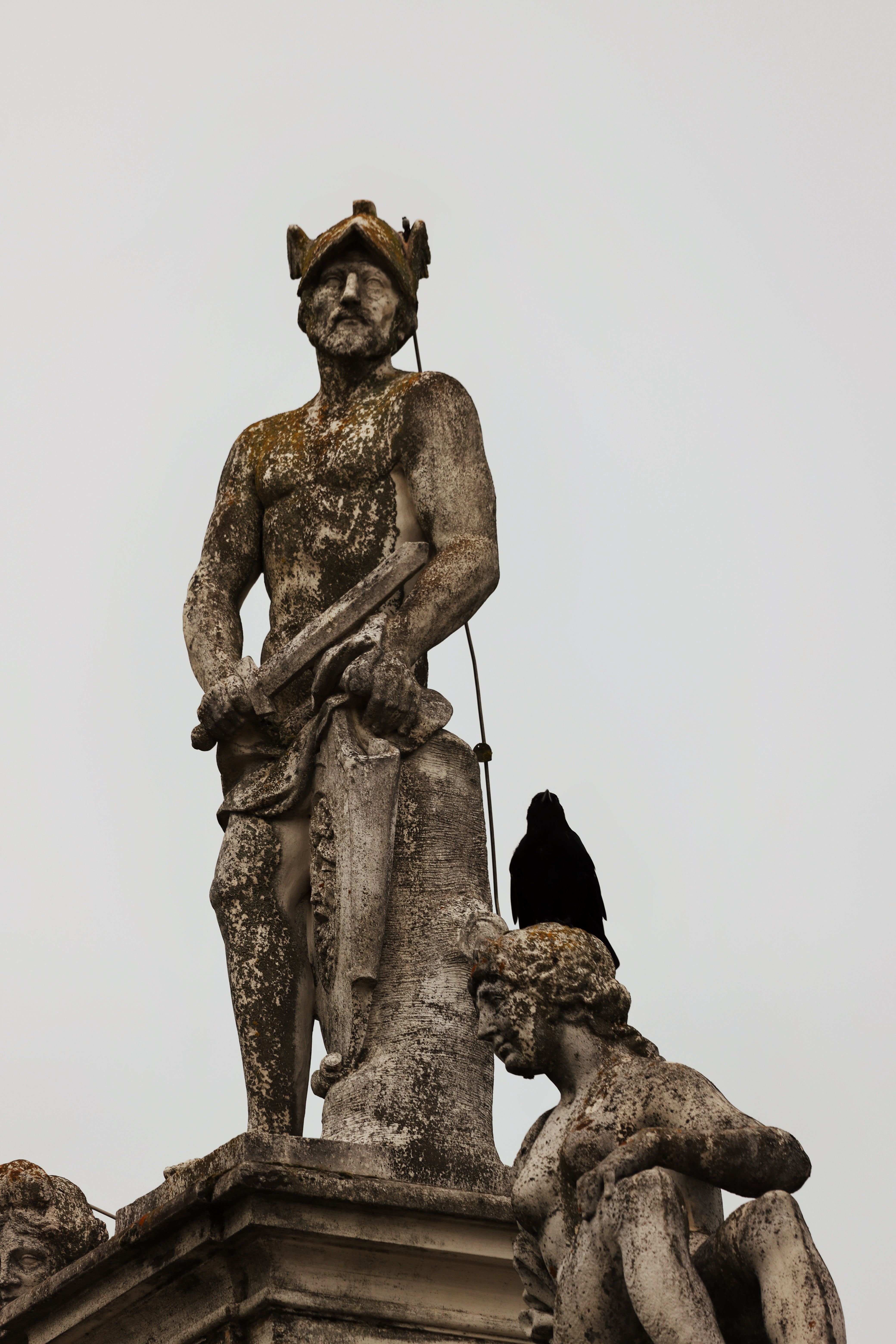 Ancient Statue with Crow in Kassel, Germany · Free Stock Photo