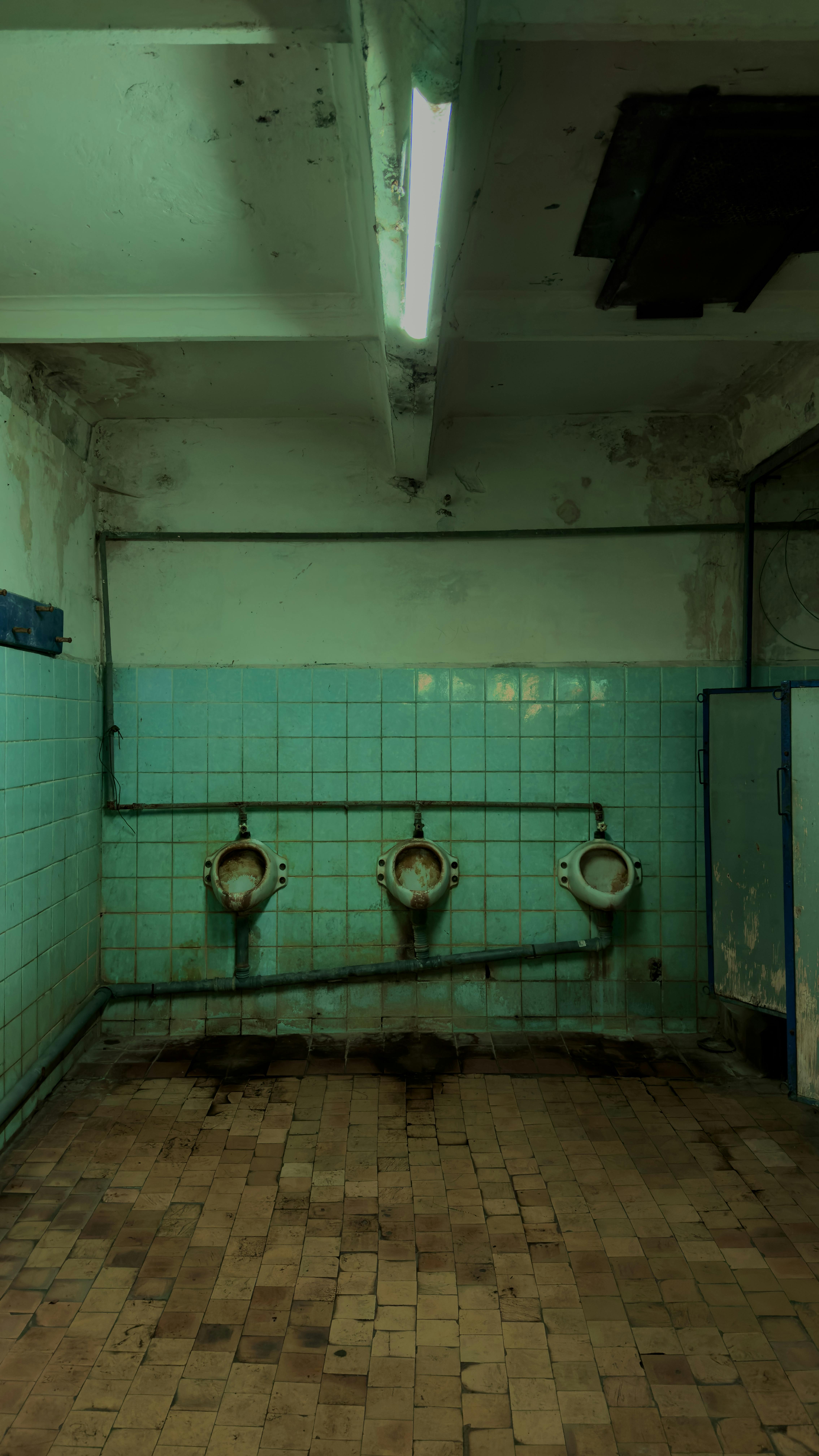 Vintage Industrial Bathroom Scene with Urinals · Free Stock Photo
