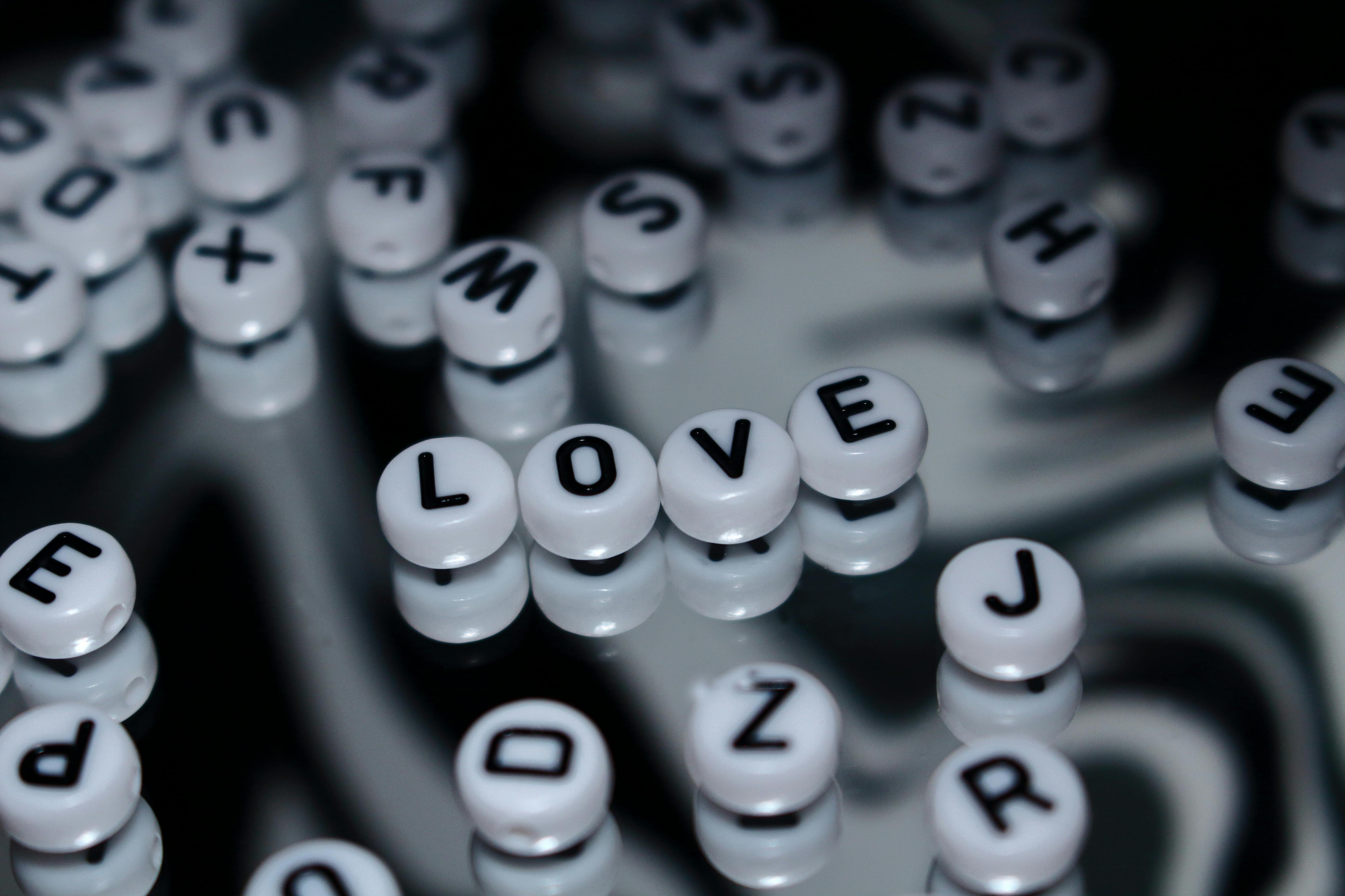 Reflective Alphabet Beads Arranged to Spell 'Love' · Free Stock Photo
