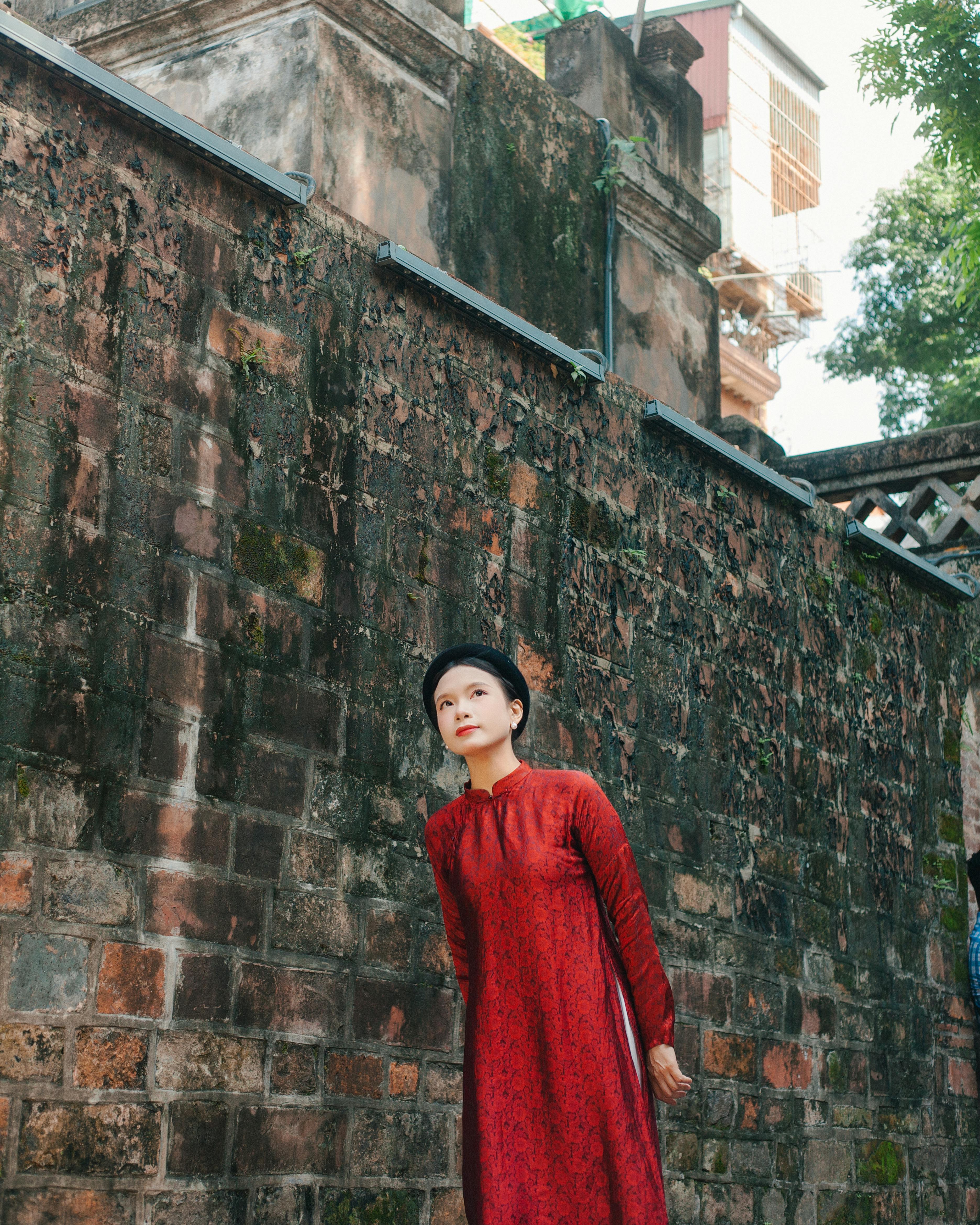 Woman in Traditional Vietnamese Attire by Old Wall · Free Stock Photo