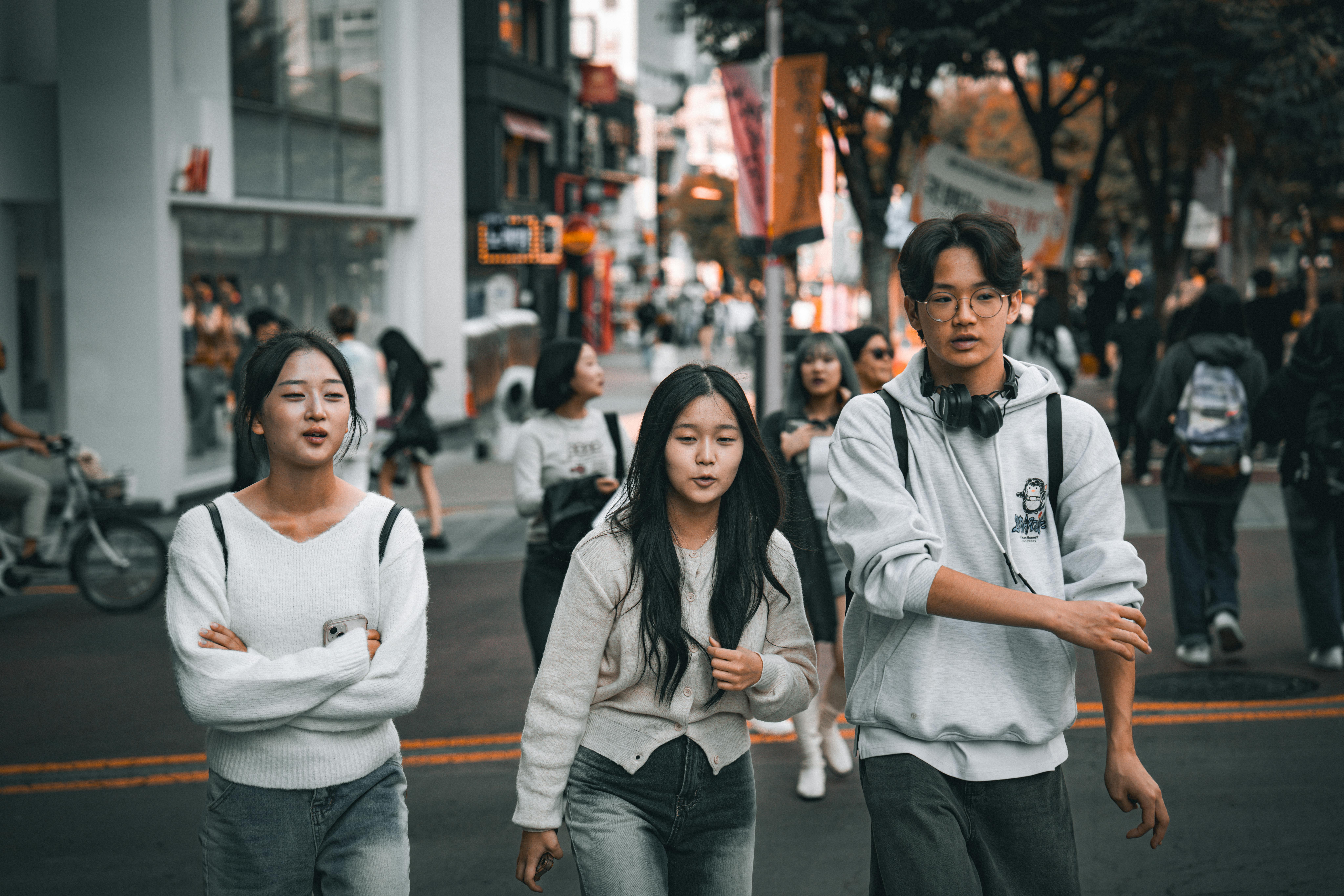 Young Friends Walking in Bustling Seoul Street Scene · Free Stock Photo